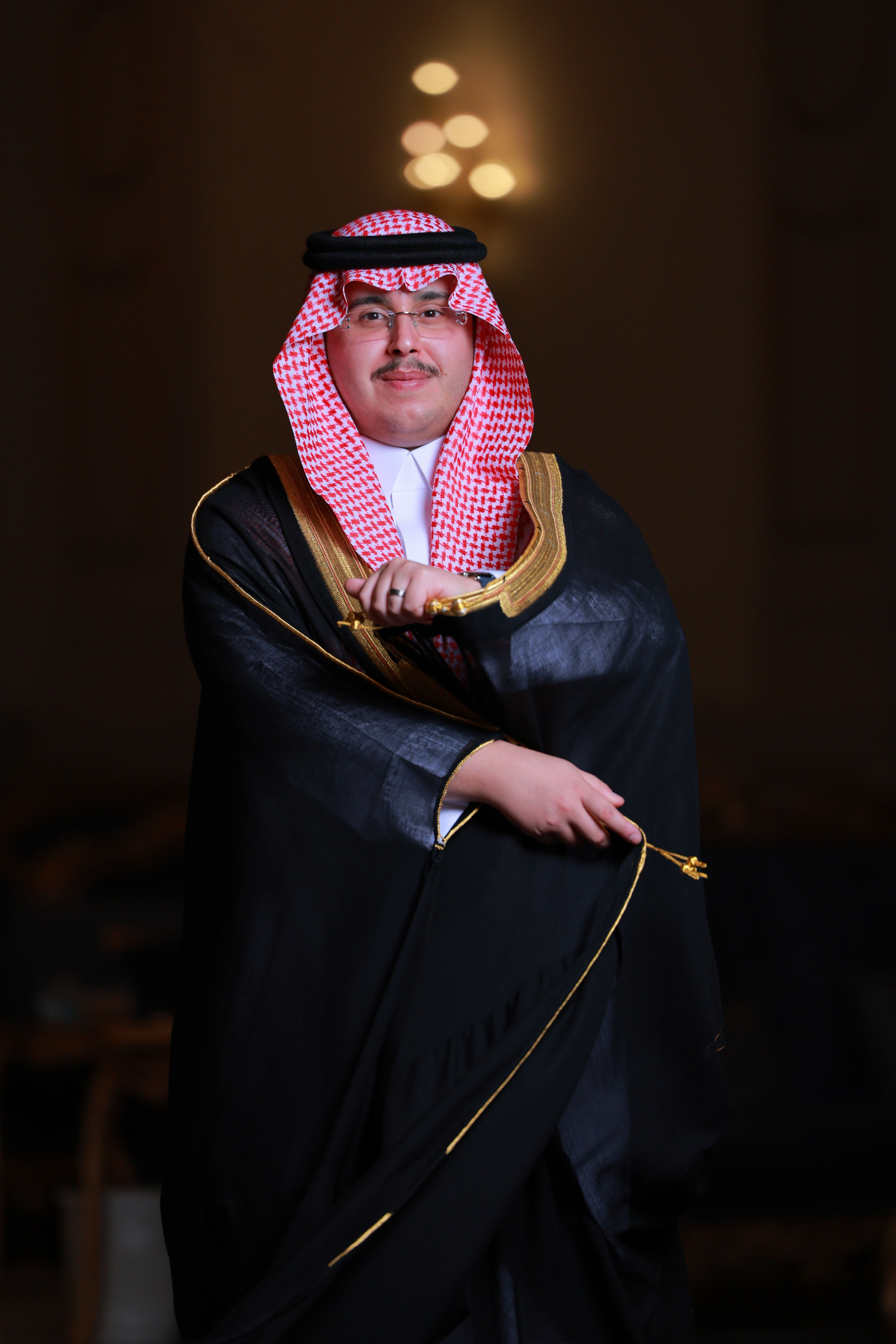A Man Wearing Traditional Saudi Clothing (Kandura) And Displaying ...