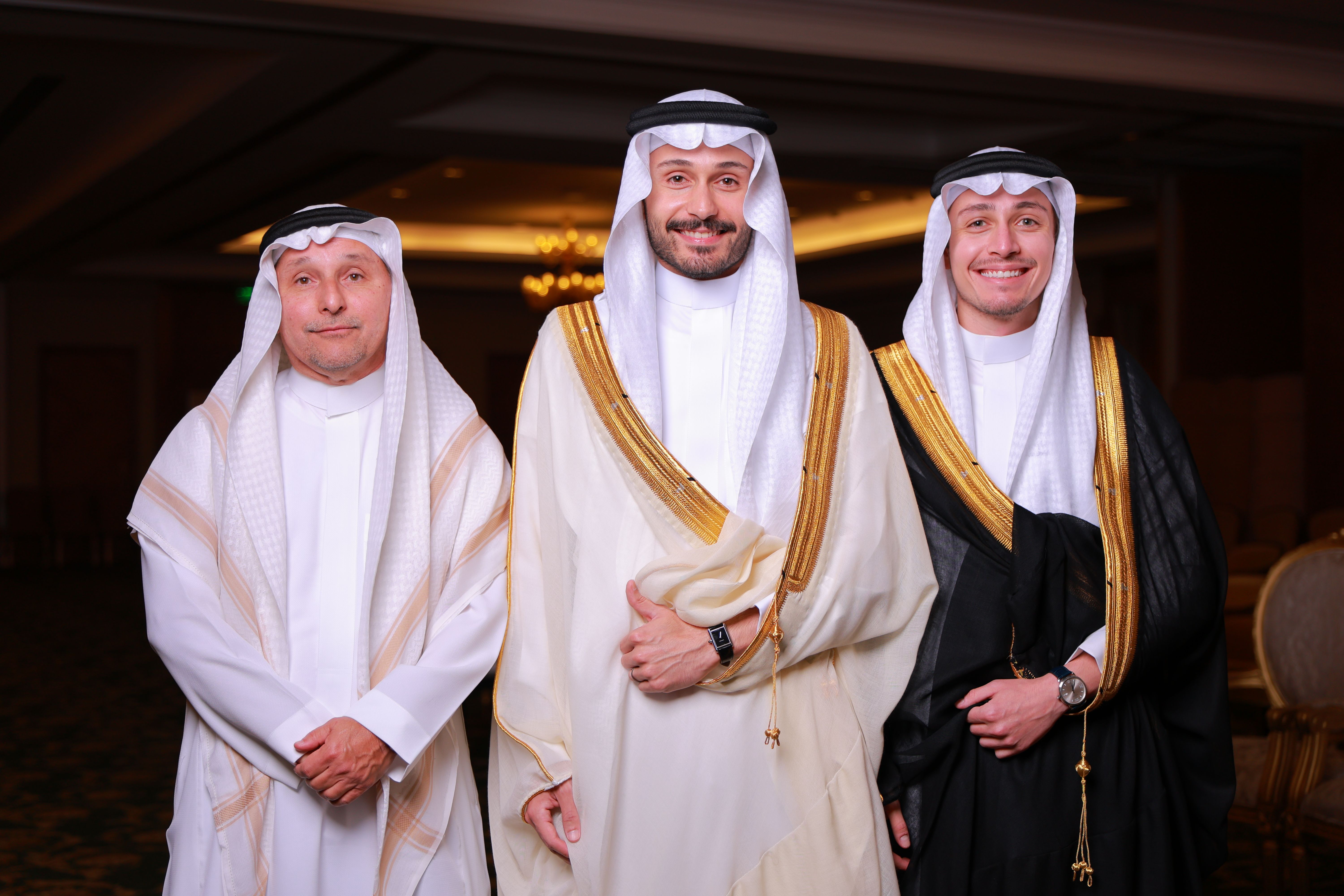 Three Men in Traditional Arabic Attire Smiling Indoors · Free Stock Photo