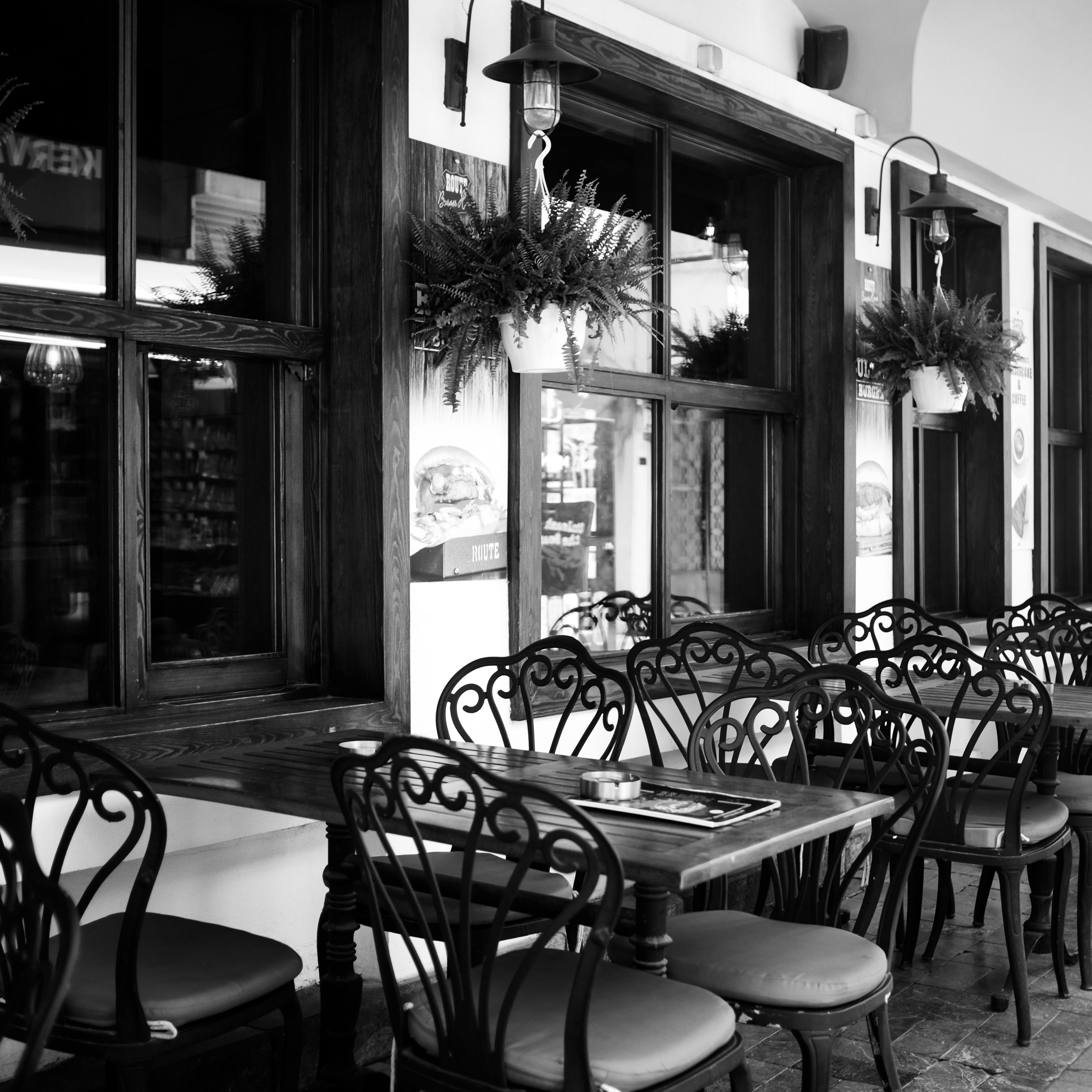 Grayscale Photography Of Inside A Coffee Shop · Free Stock Photo