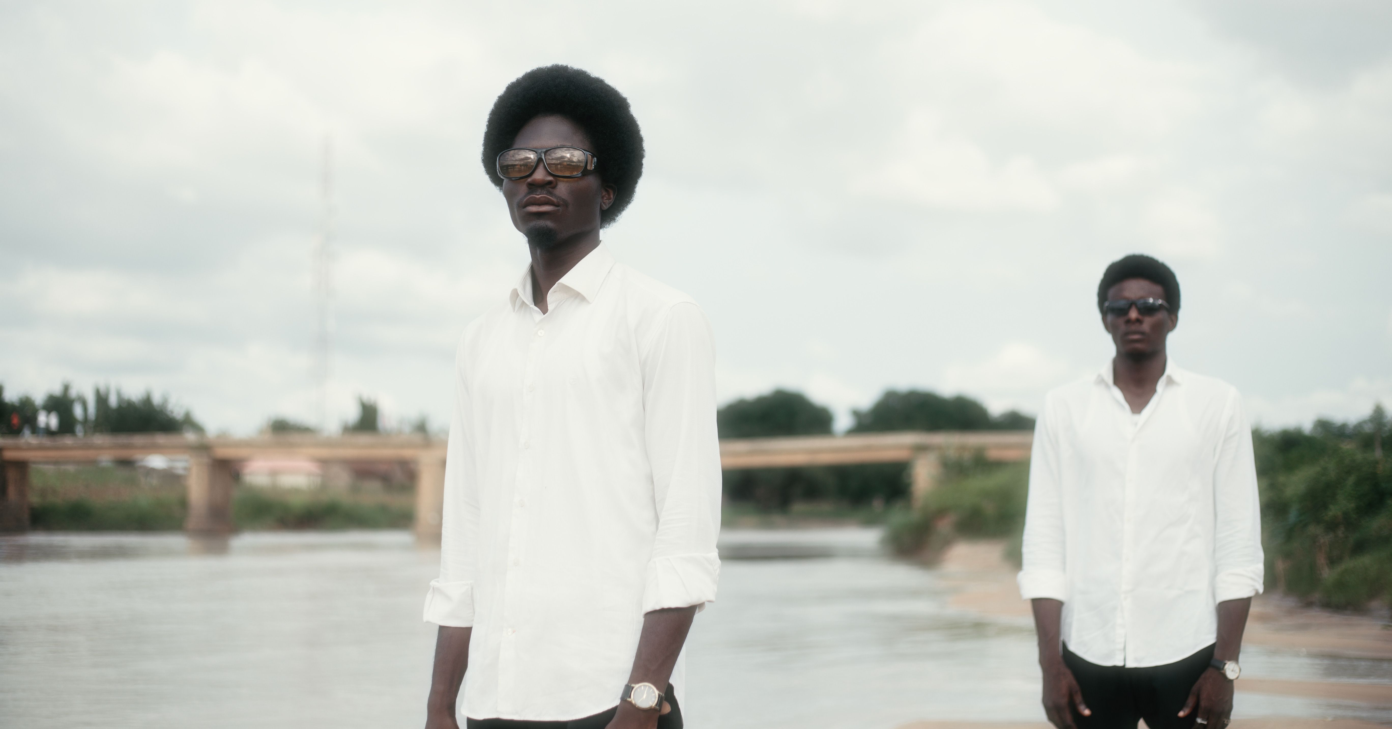 Stylish Men Posing by River in White Shirts · Free Stock Photo