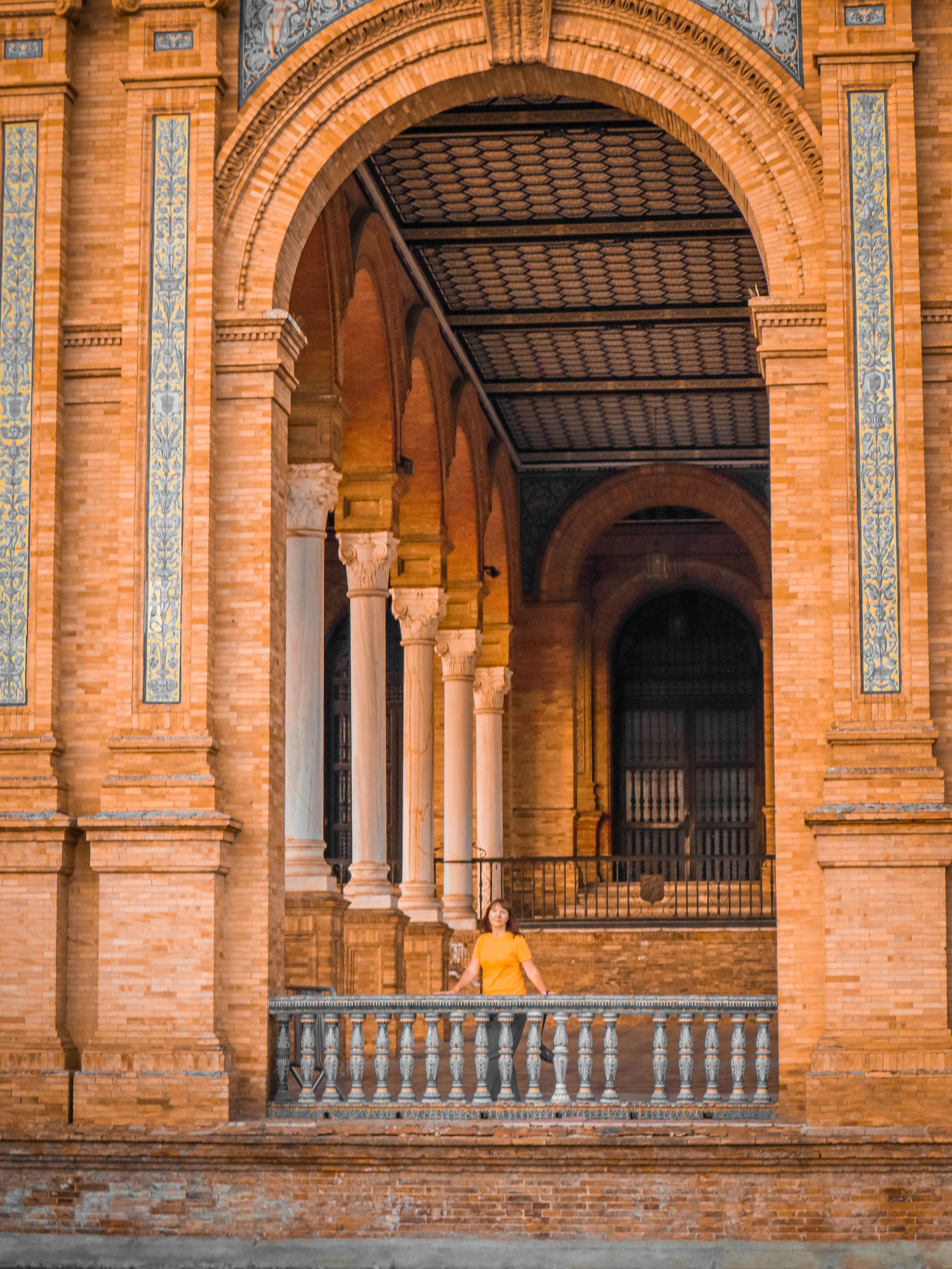 Woman Standing in Plaza de España Archway · Free Stock Photo