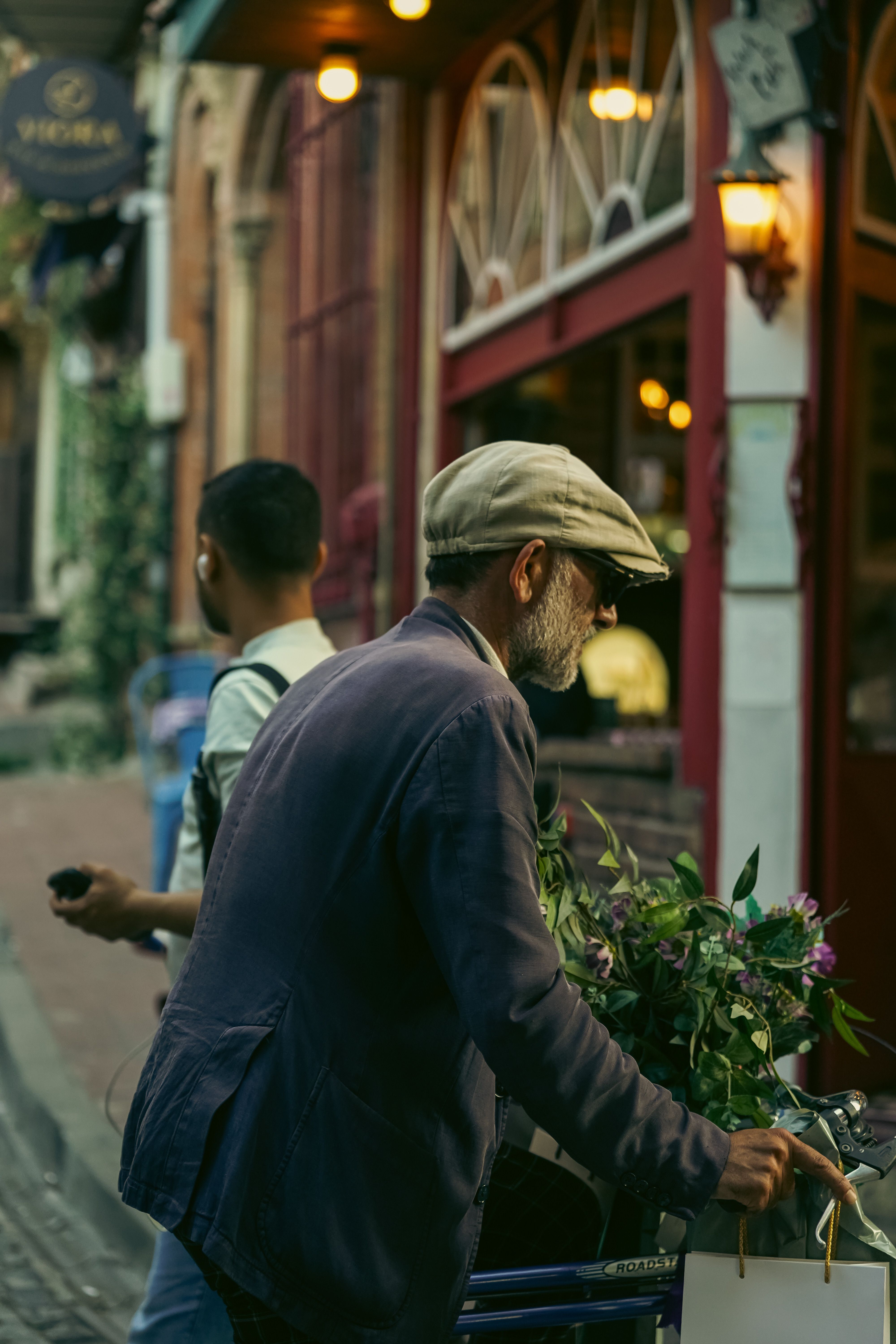 Man with Bicycle on European Street Corner · Free Stock Photo