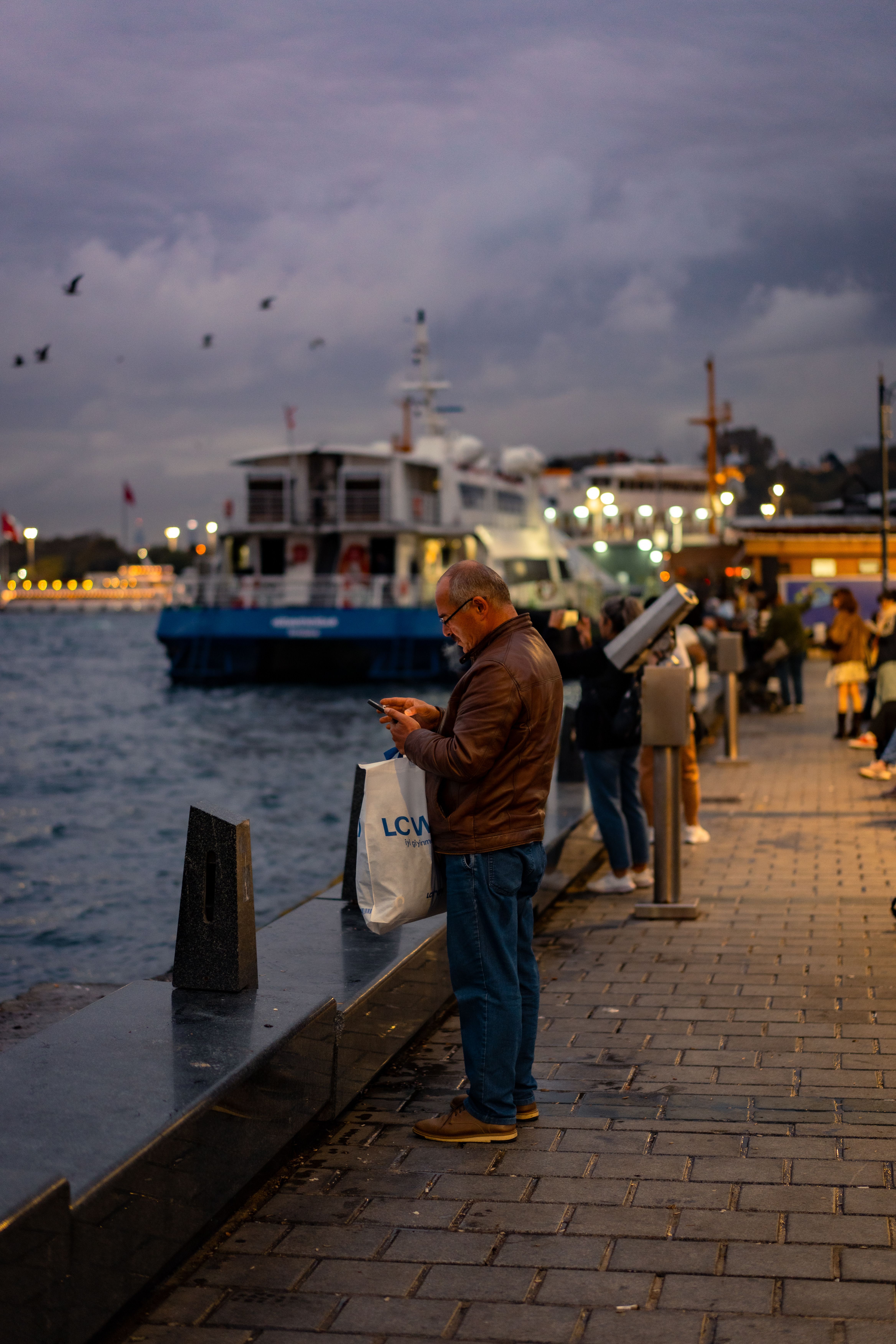 Evening at Waterfront Promenade with Boat Docked · Free Stock Photo