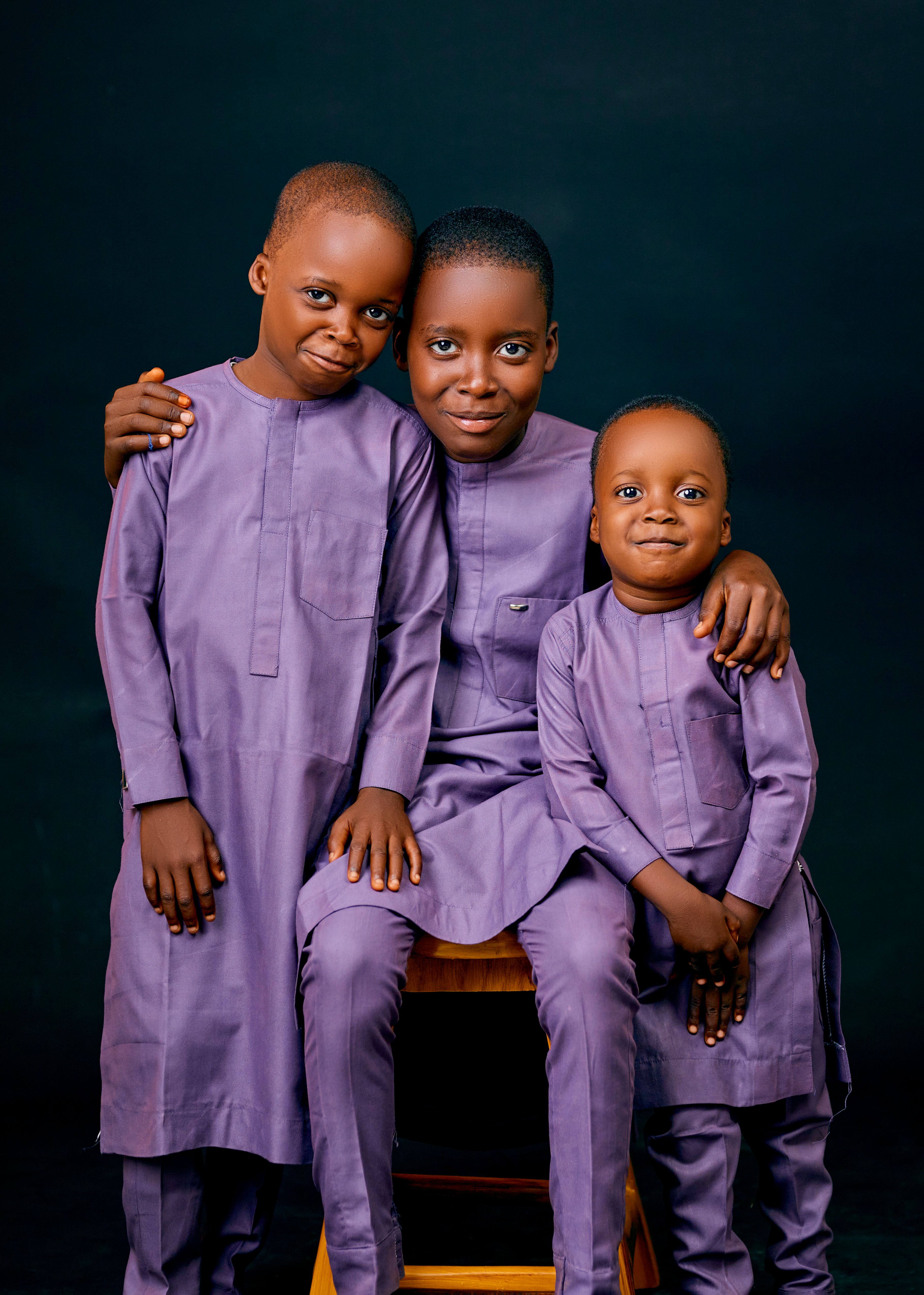 Three Smiling Boys in Purple Traditional Attire · Free Stock Photo