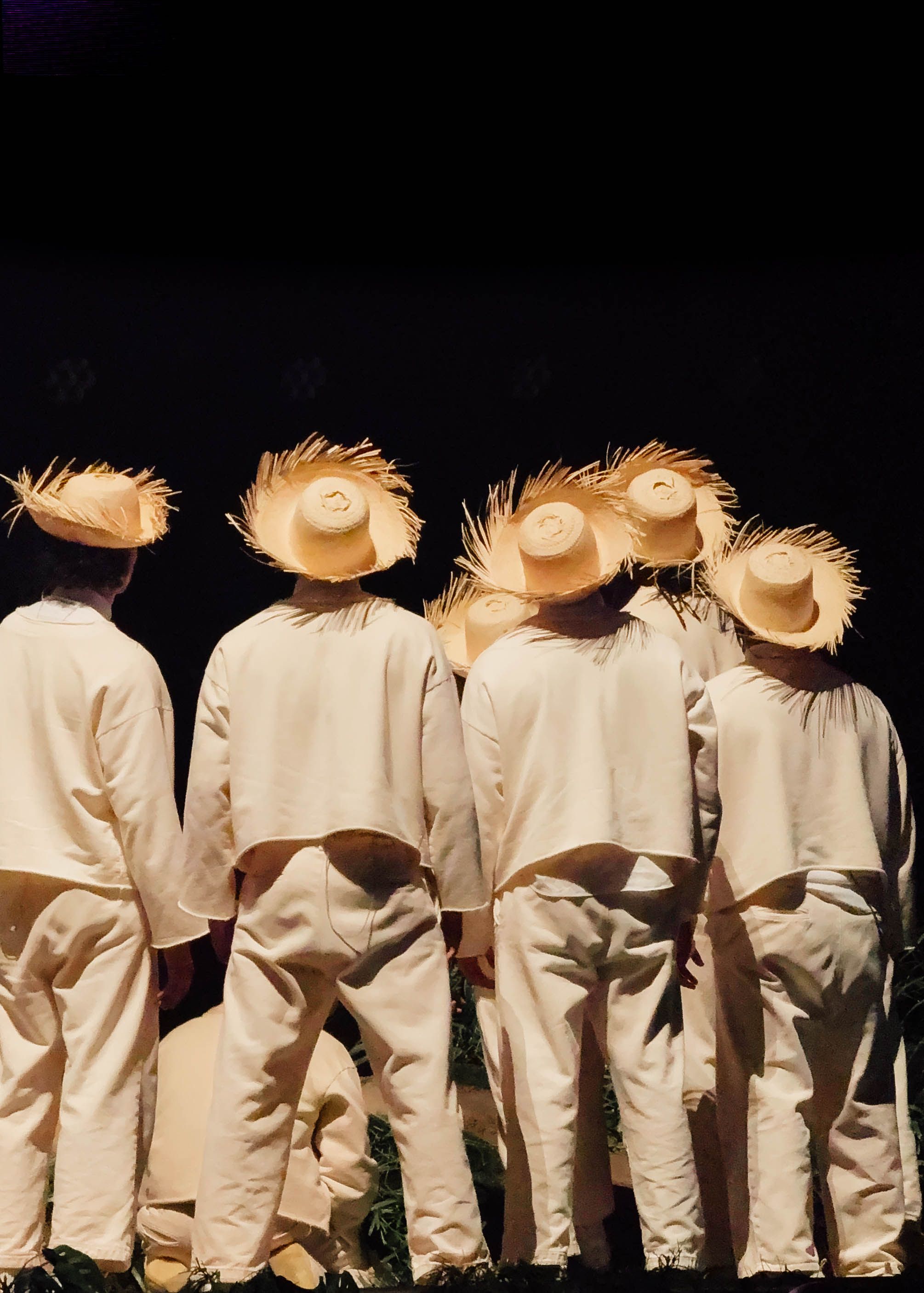 Traditional Dancers in Straw Hats on Stage · Free Stock Photo