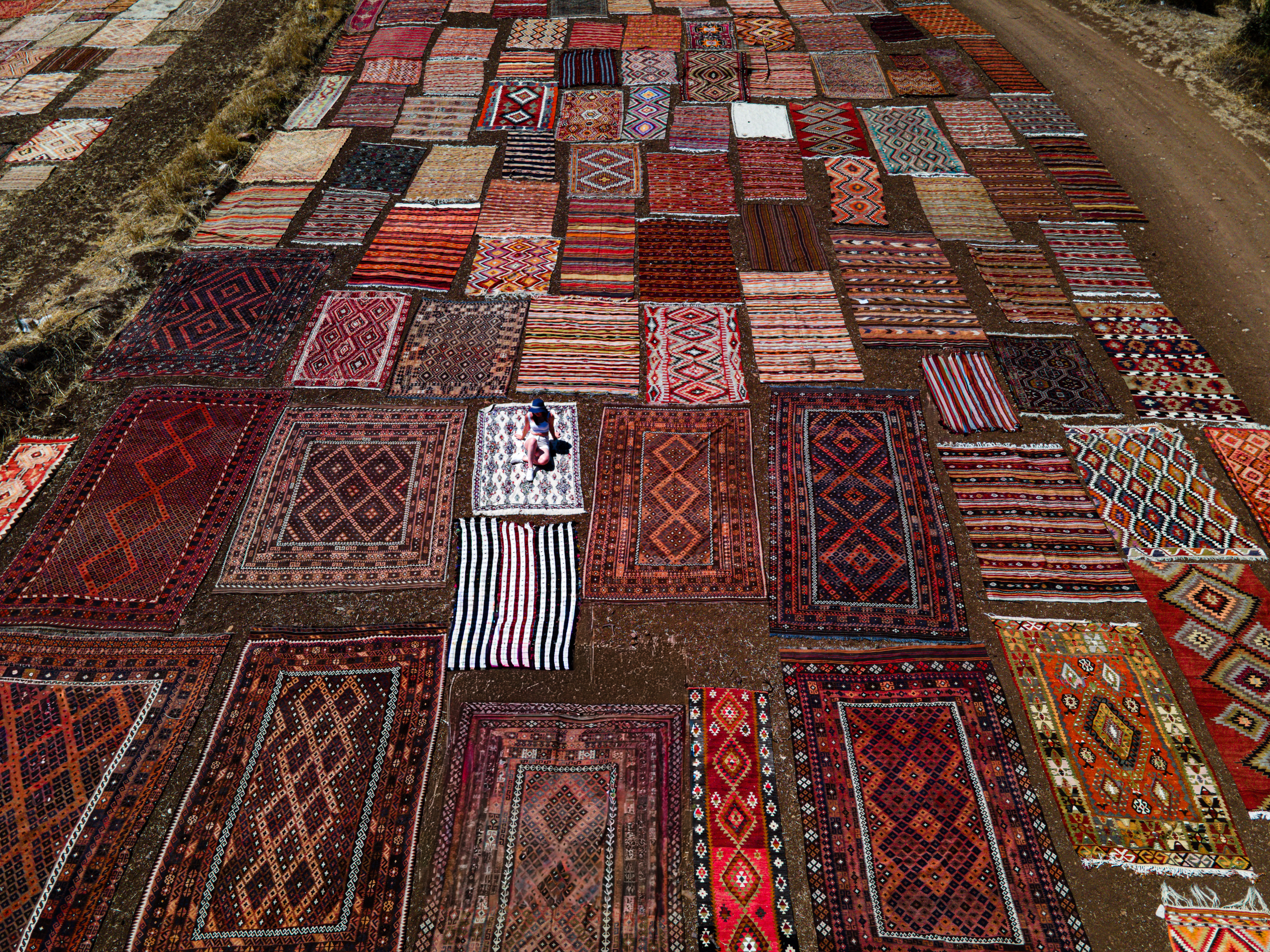Aerial View of Colorful Turkish Rugs Displayed Outdoors · Free Stock Photo