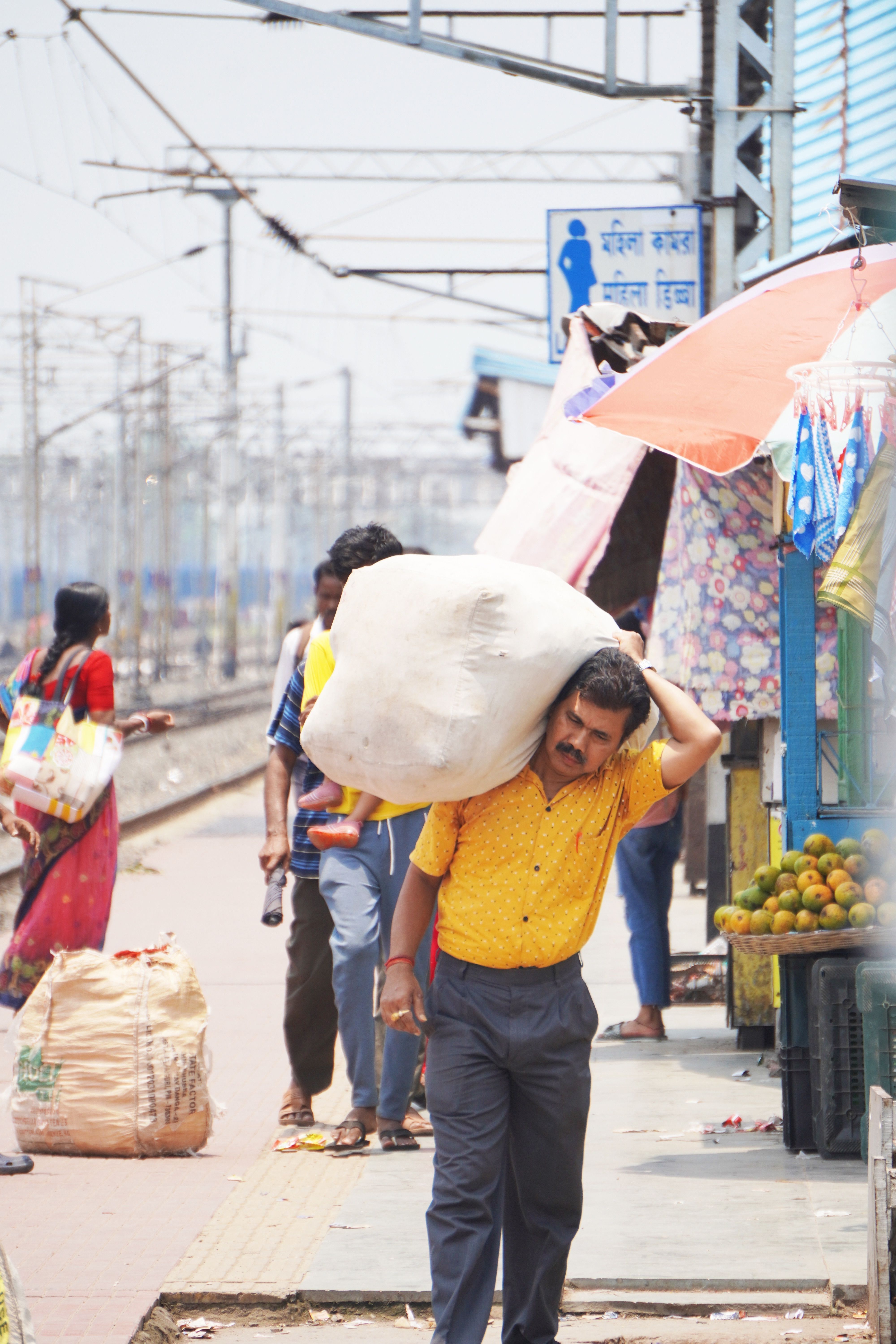 Man Carrying Heavy Bag on Head · Free Stock Photo