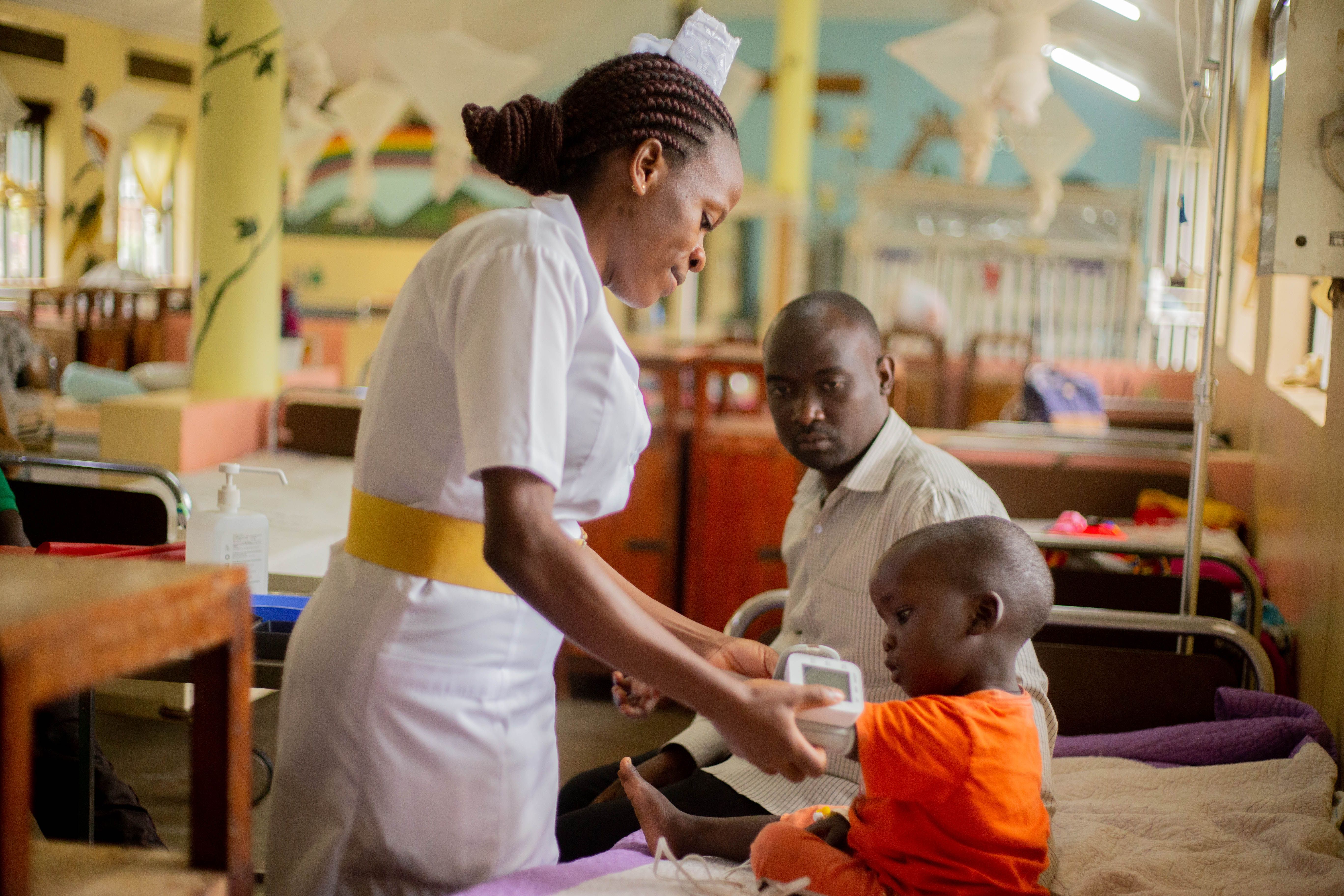 Nurse Caring for Child in Hospital Setting · Free Stock Photo