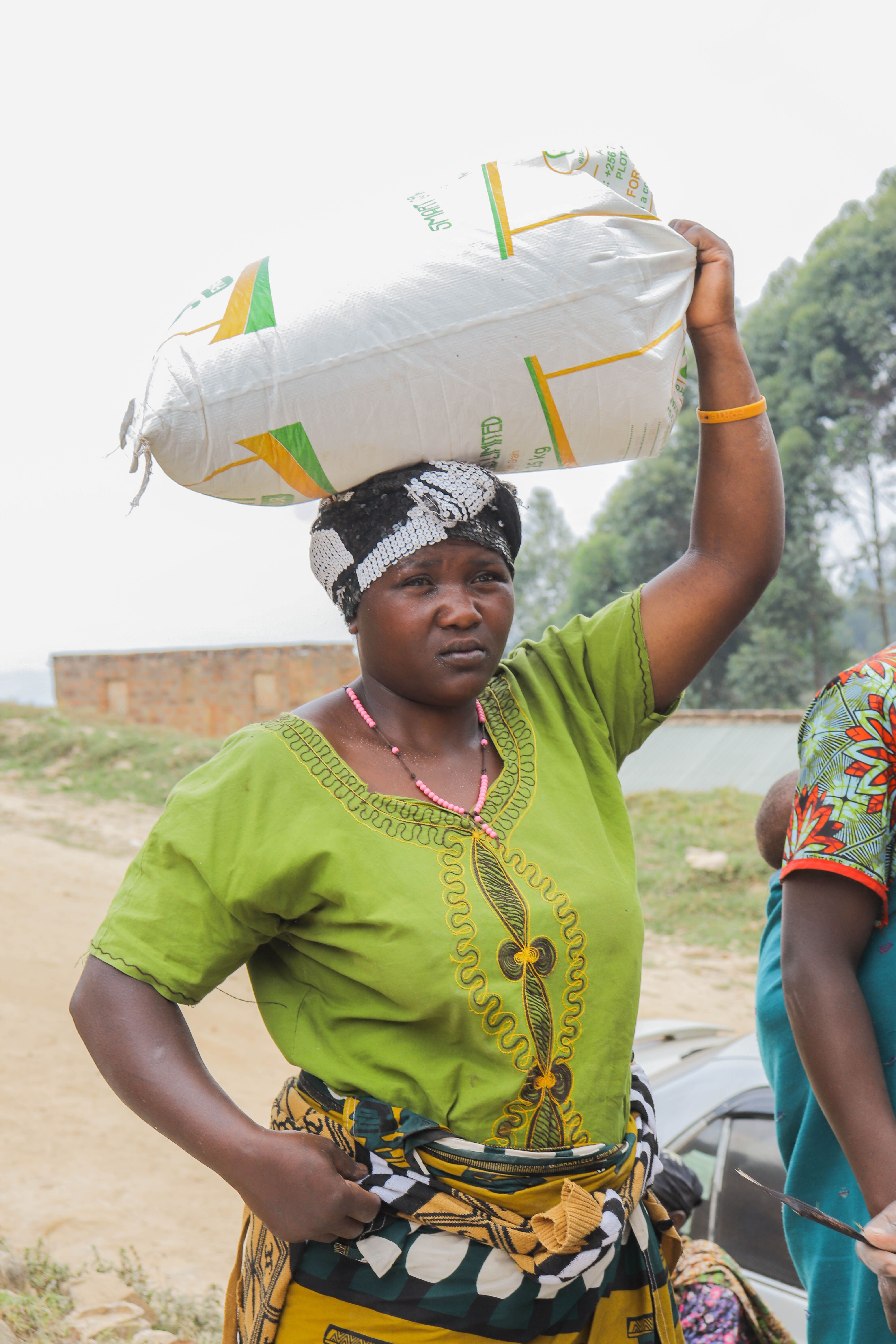 African Woman Carrying Sack Outdoors · Free Stock Photo