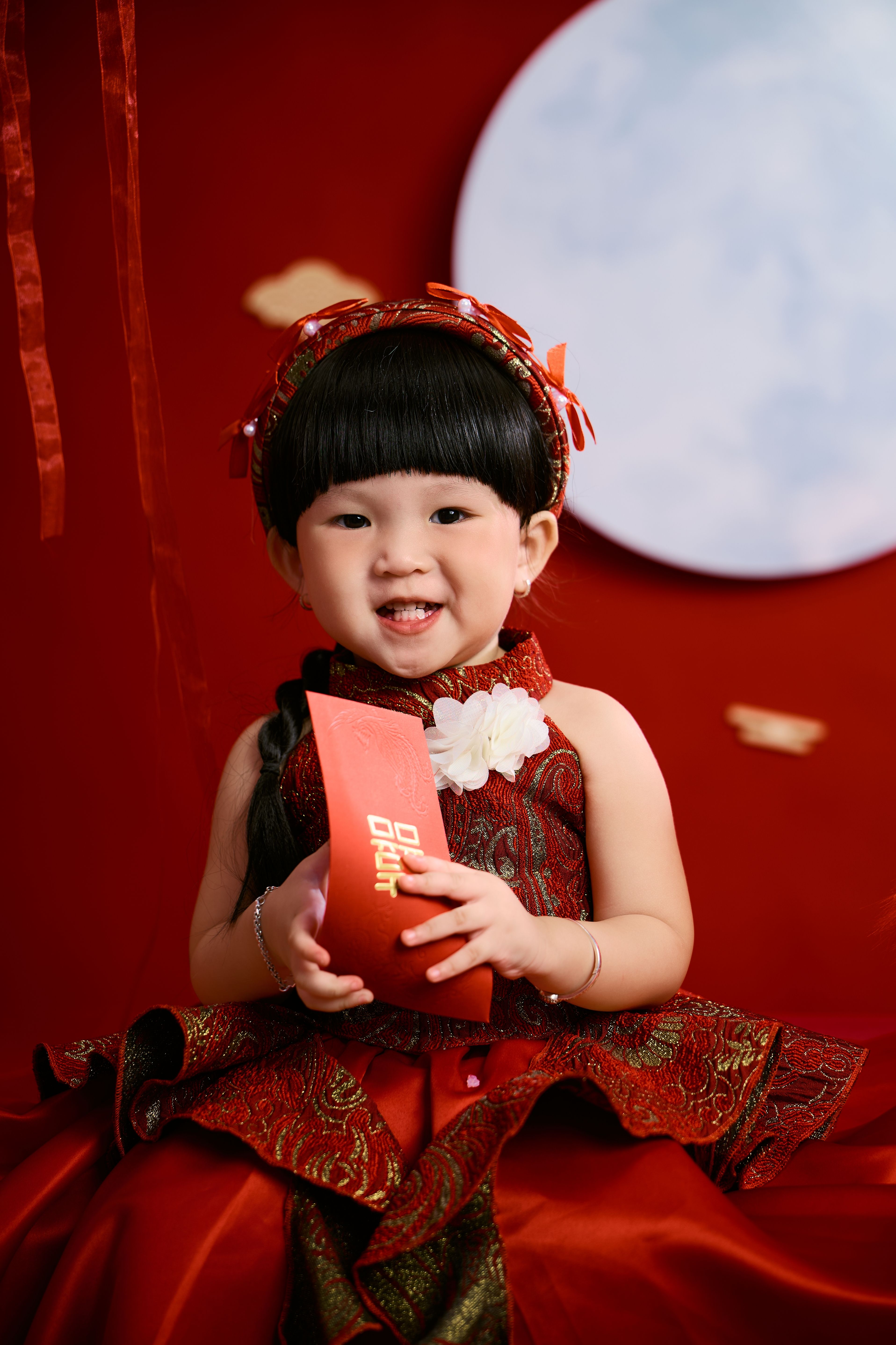 Adorable Child Holding Red Envelope in Traditional Dress · Free Stock Photo
