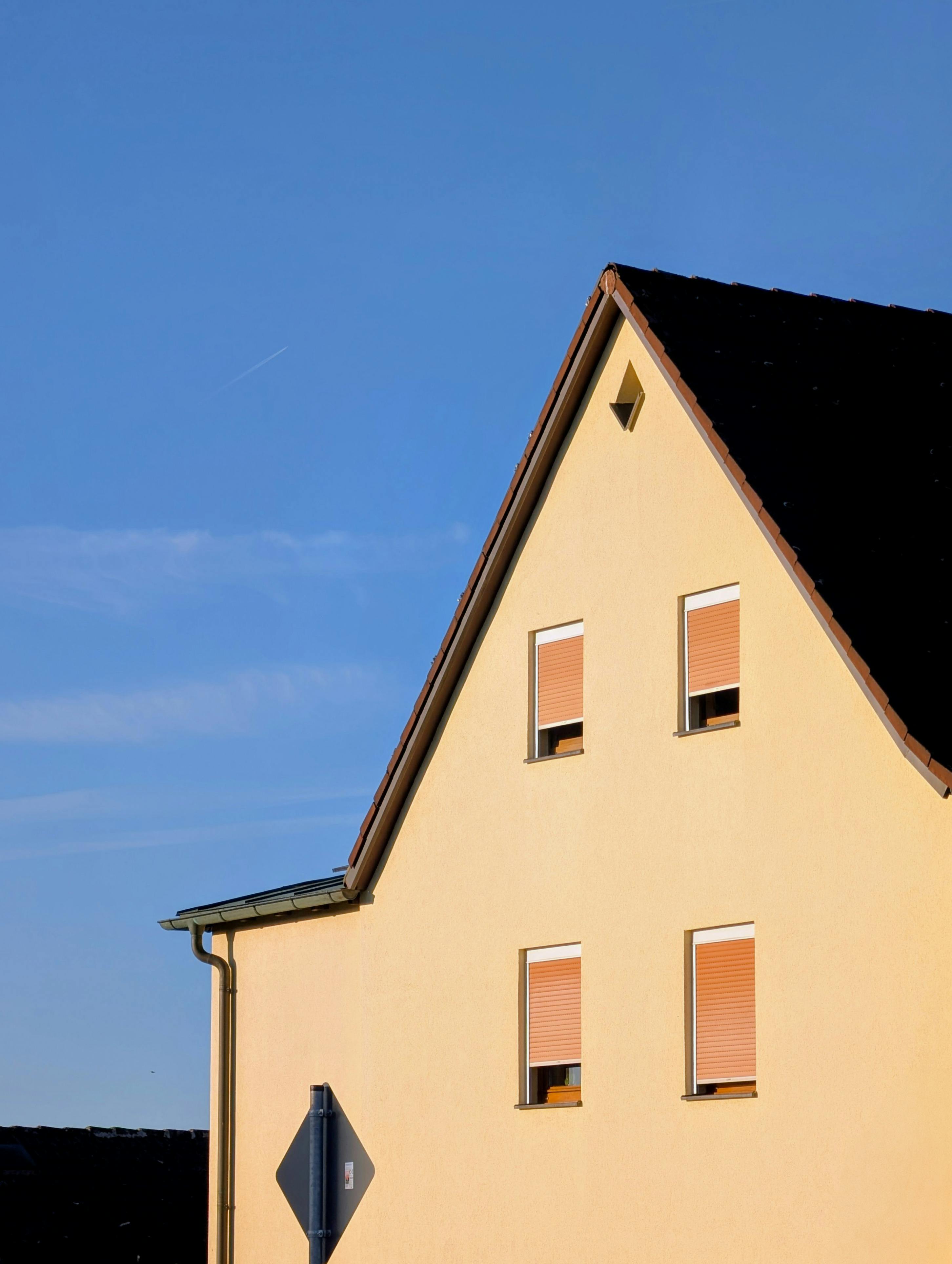 Gable Roof House Against Clear Blue Sky · Free Stock Photo