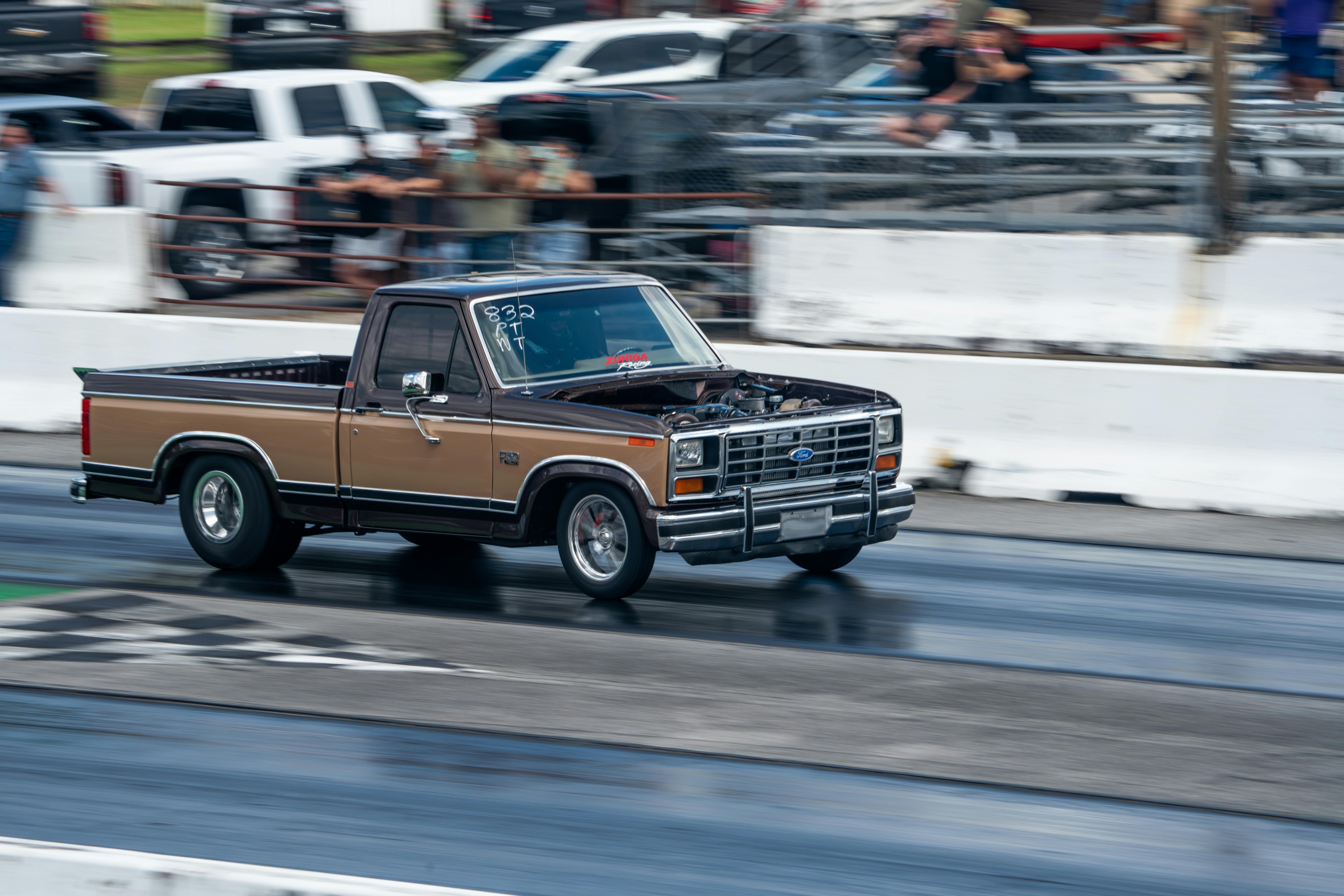 High-Speed Blue Pickup Truck on Race Track · Free Stock Photo