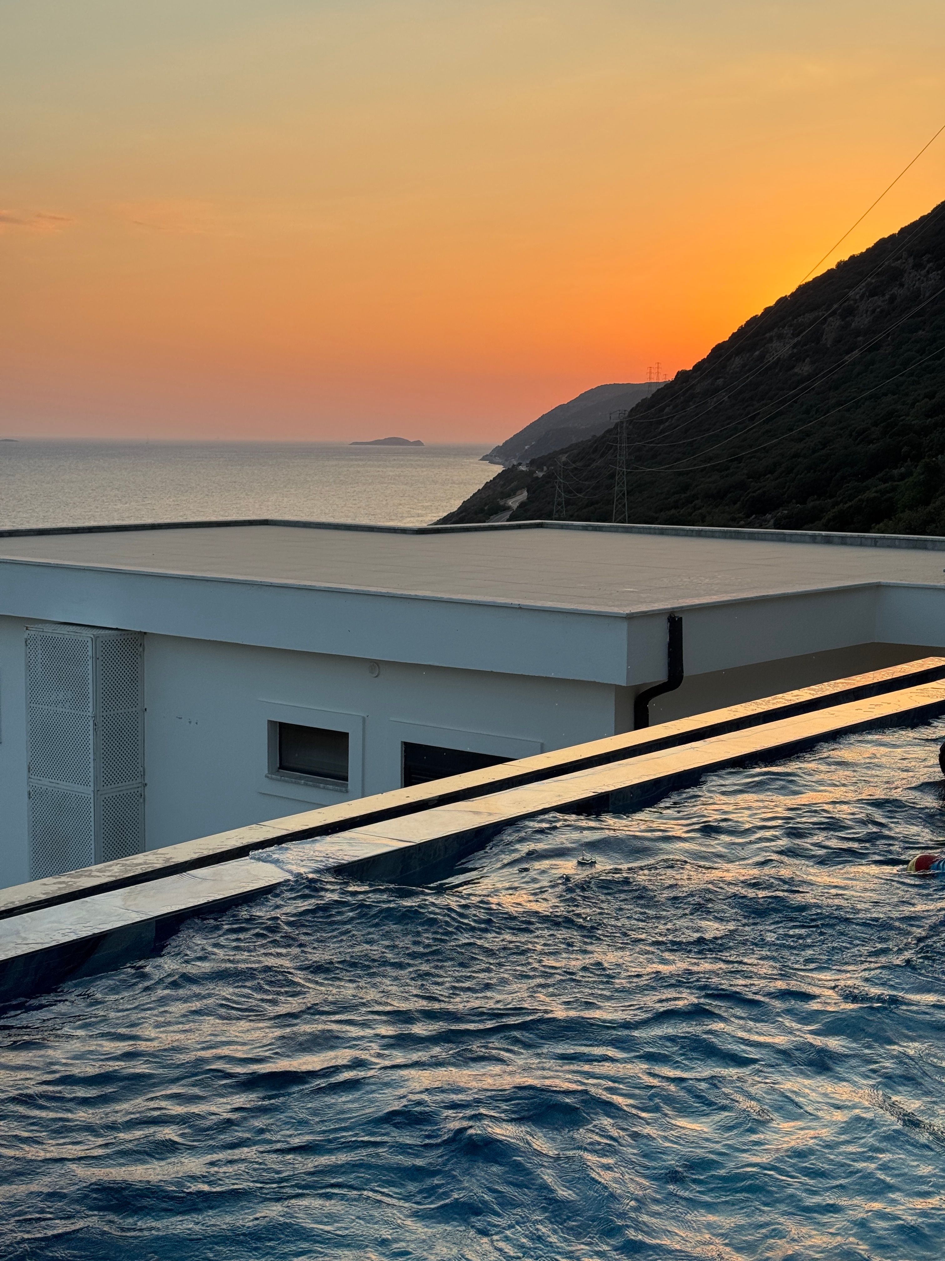 Modern Pool Overlooking Ocean at Sunset · Free Stock Photo