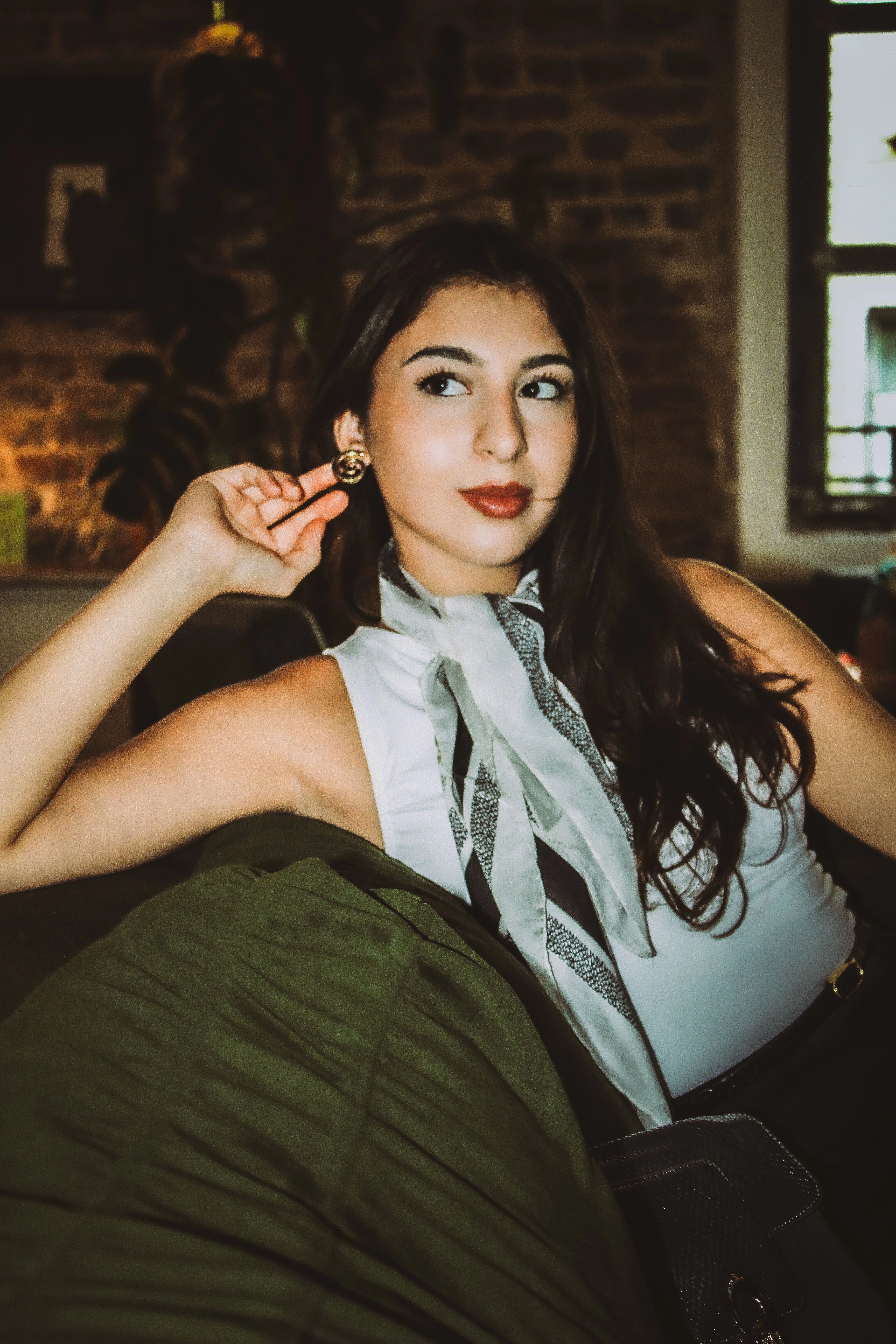 Elegant Woman Posing Indoors with Stylish Outfit · Free Stock Photo