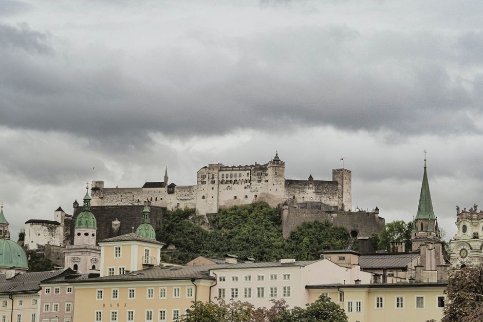 Scenic view of Hohensalzburg Fortress overlooking colorful historic buildings in Salzburg.