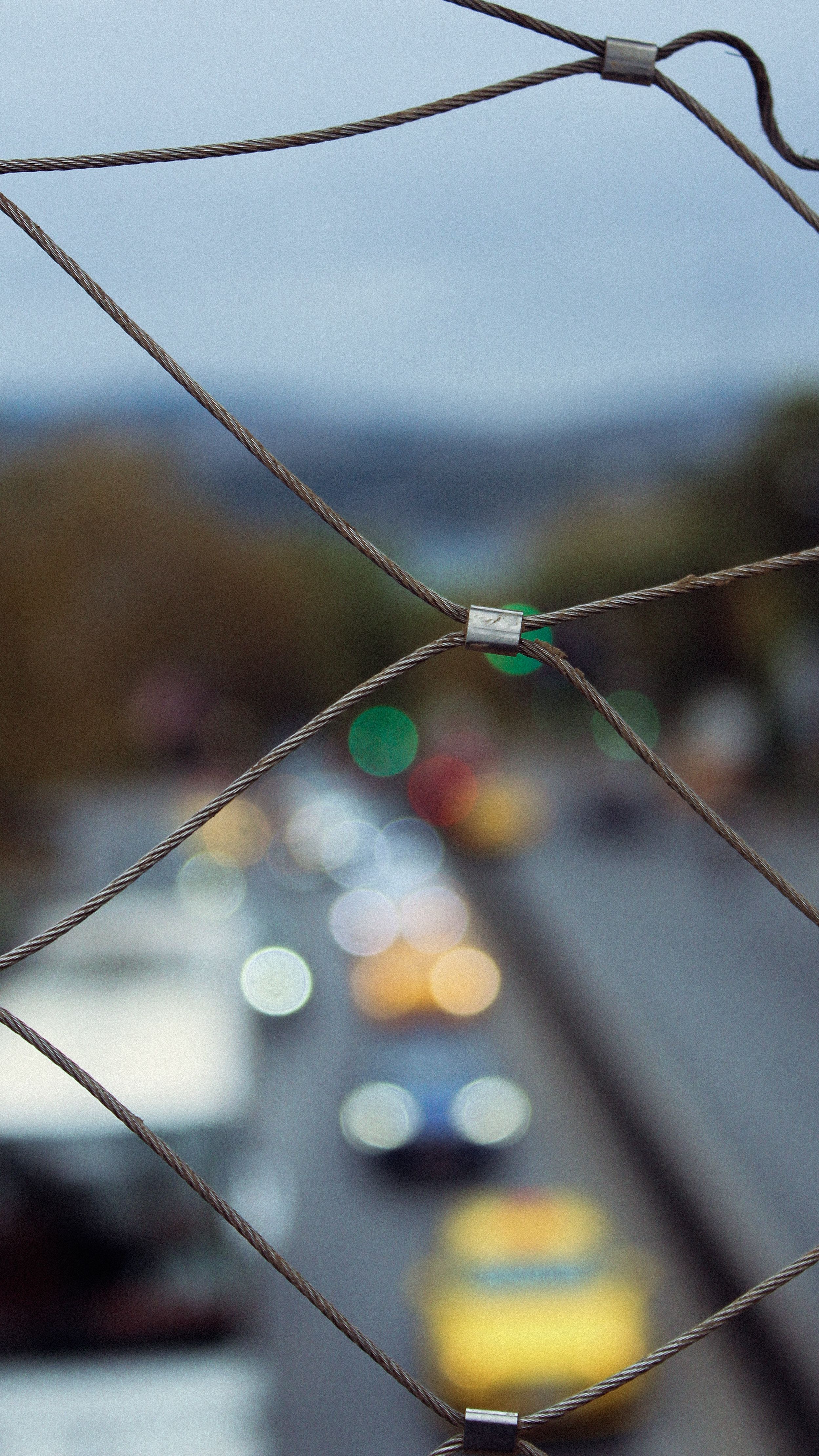Urban Road View Through Wire Fence · Free Stock Photo