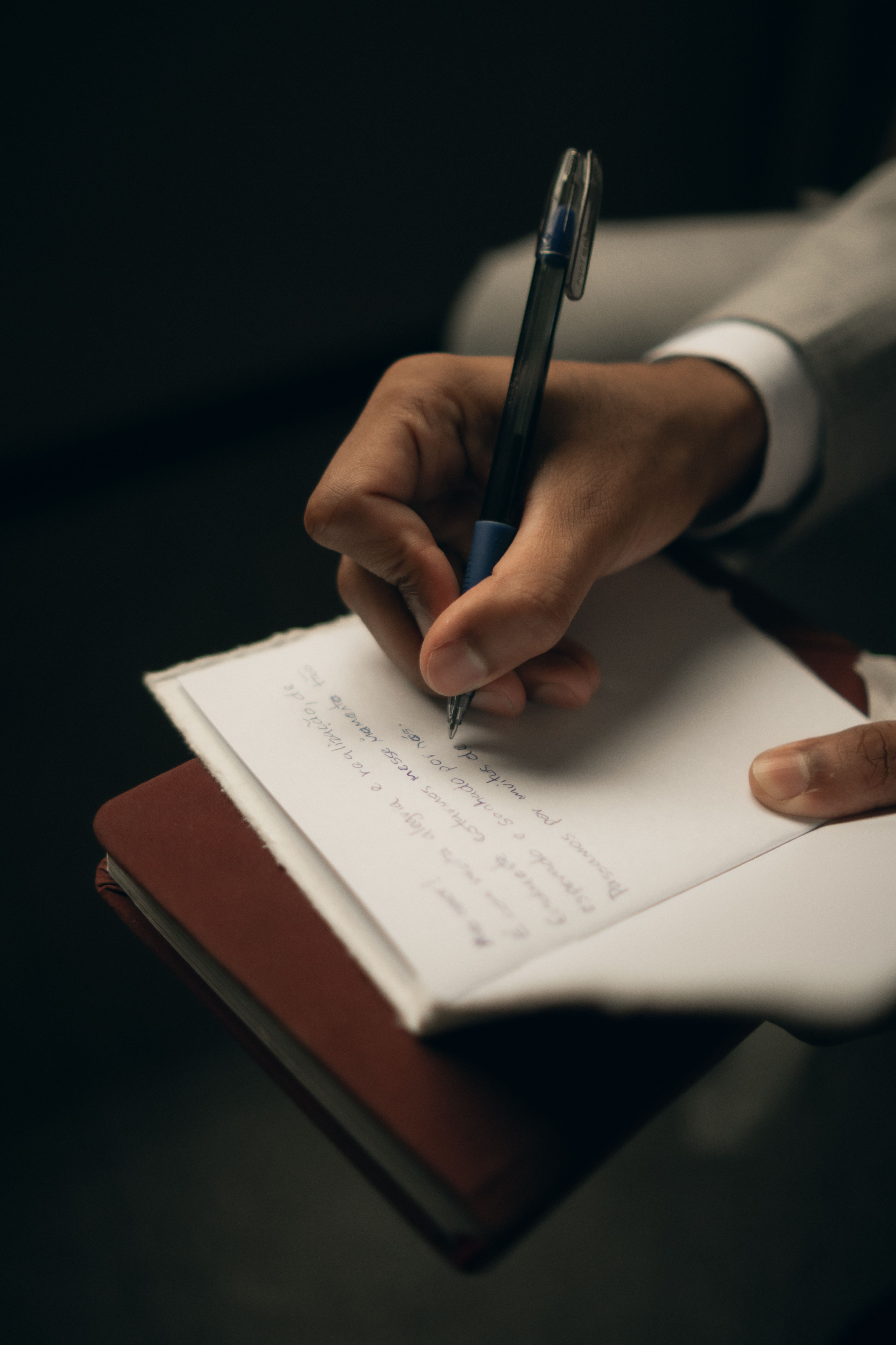 Close-up of Hand Writing in Notebook · Free Stock Photo