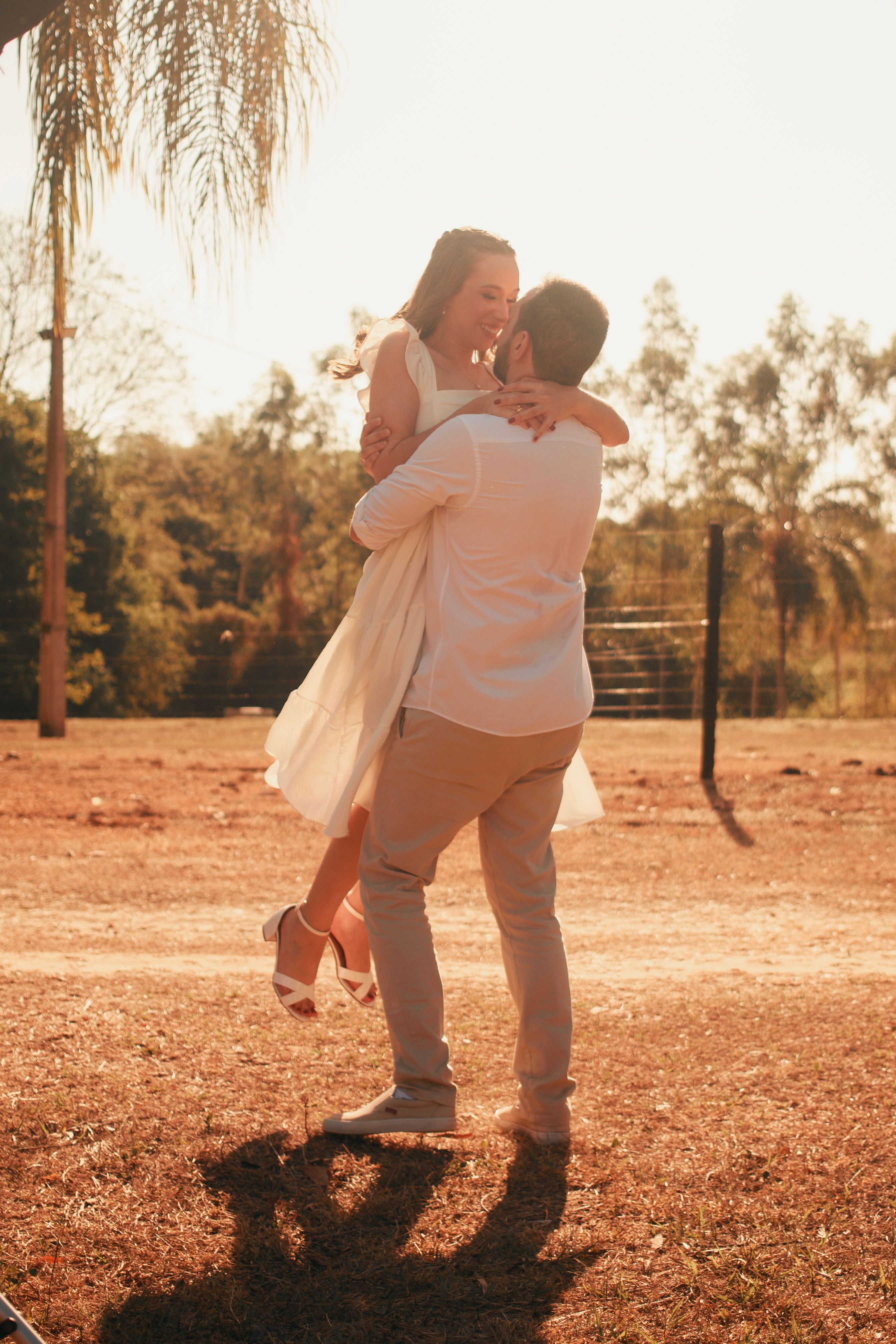 Romantic Couple Embracing Outdoors in Golden Light · Free Stock Photo