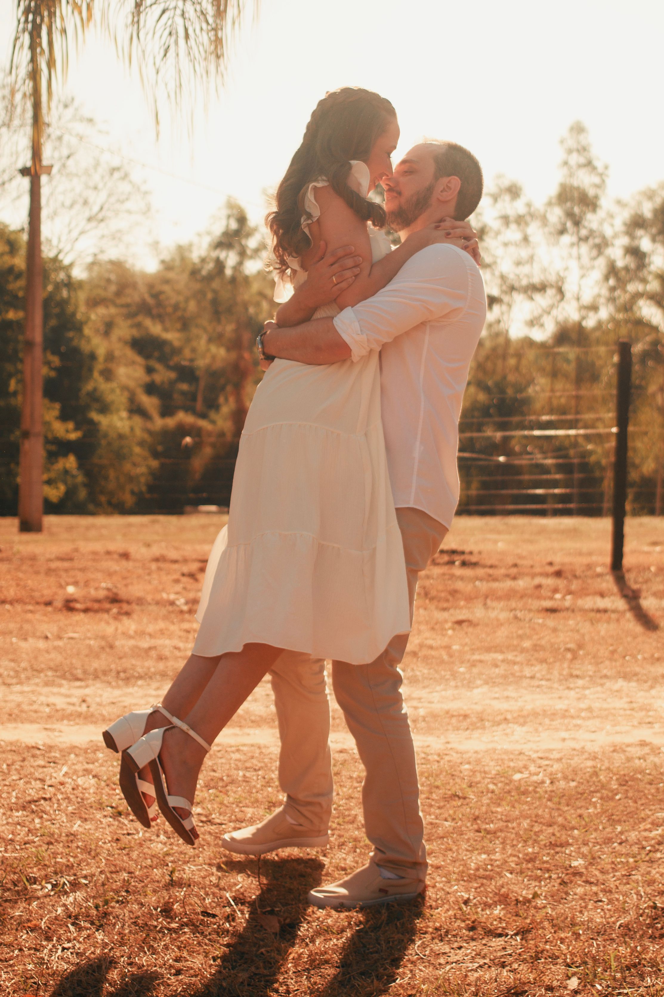 Romantic Couple Embracing Outdoors at Sunset · Free Stock Photo