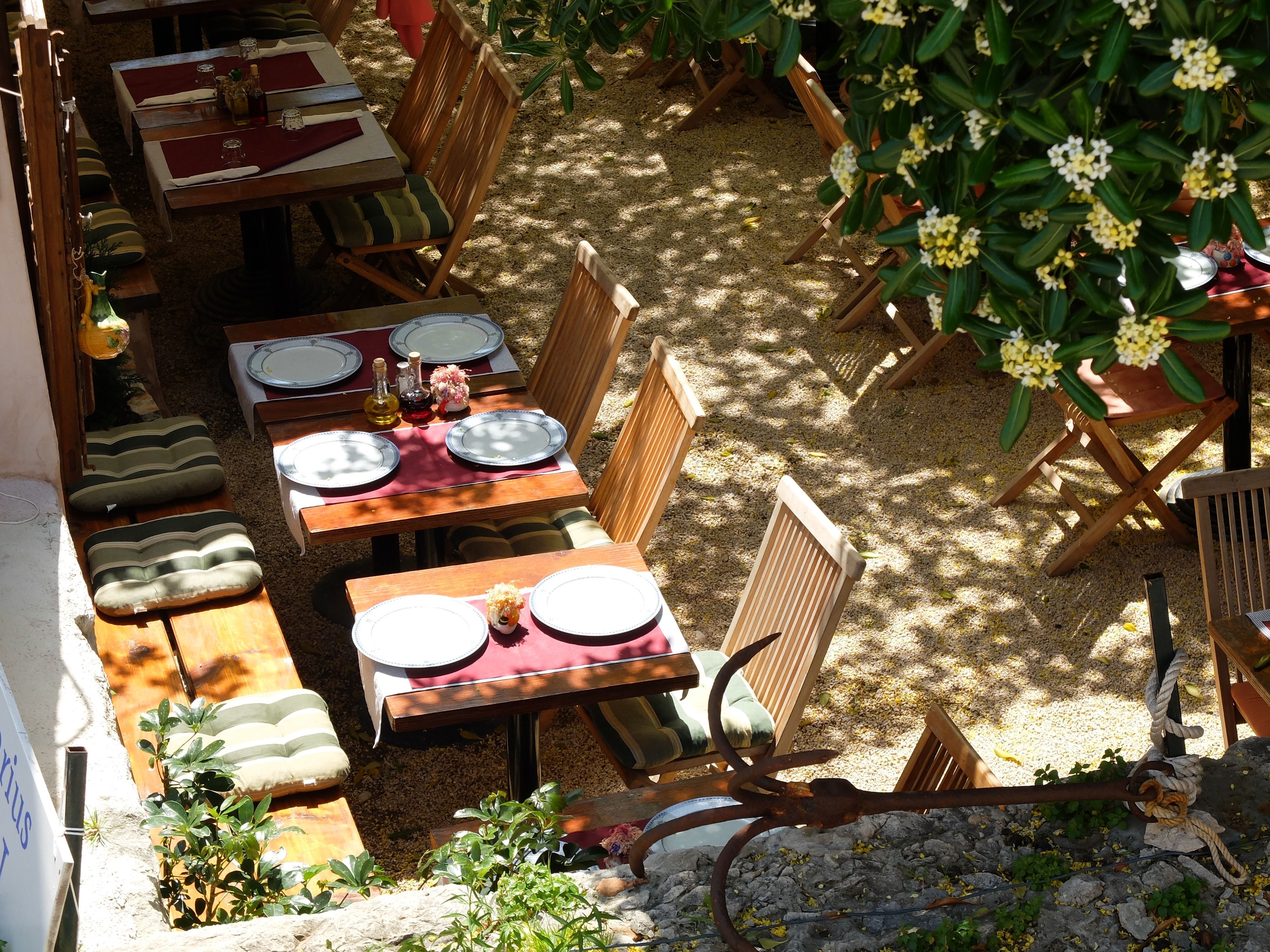 Cozy Outdoor Cafe Seating with Umbrella · Free Stock Photo