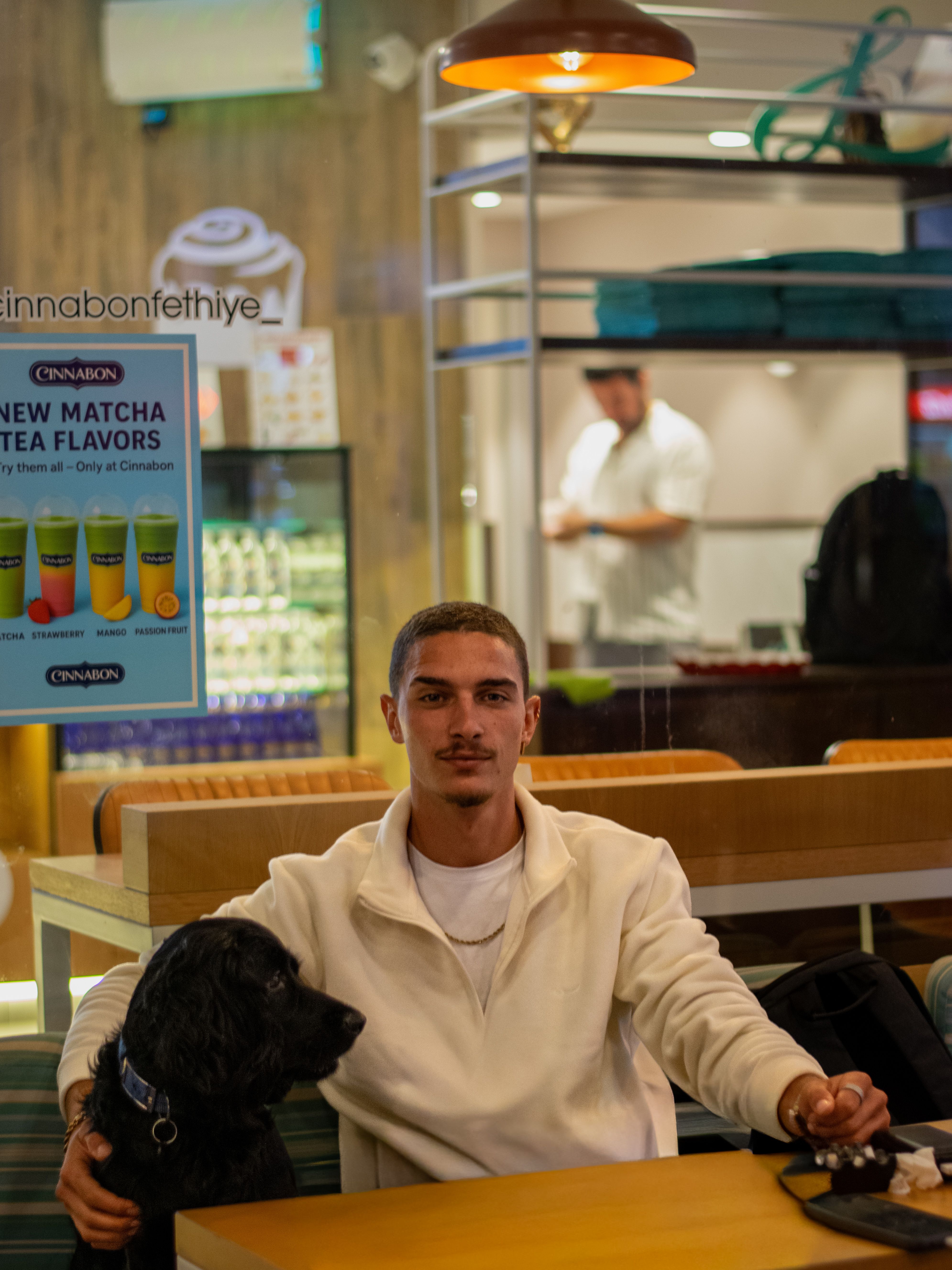 Man and Dog at a Cinnabon Cafe · Free Stock Photo