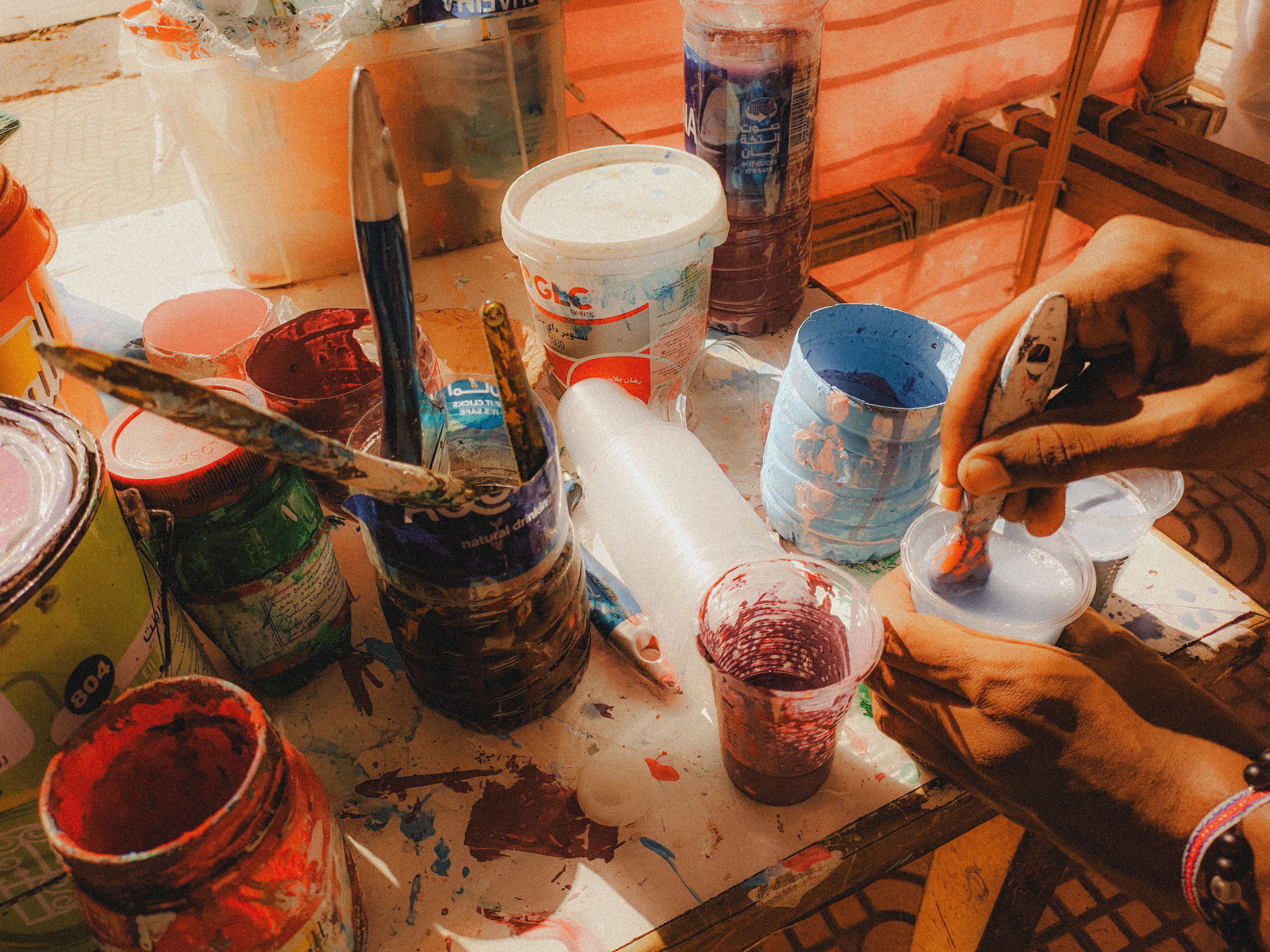 Art Supplies on a Table with Mixed Paints · Free Stock Photo