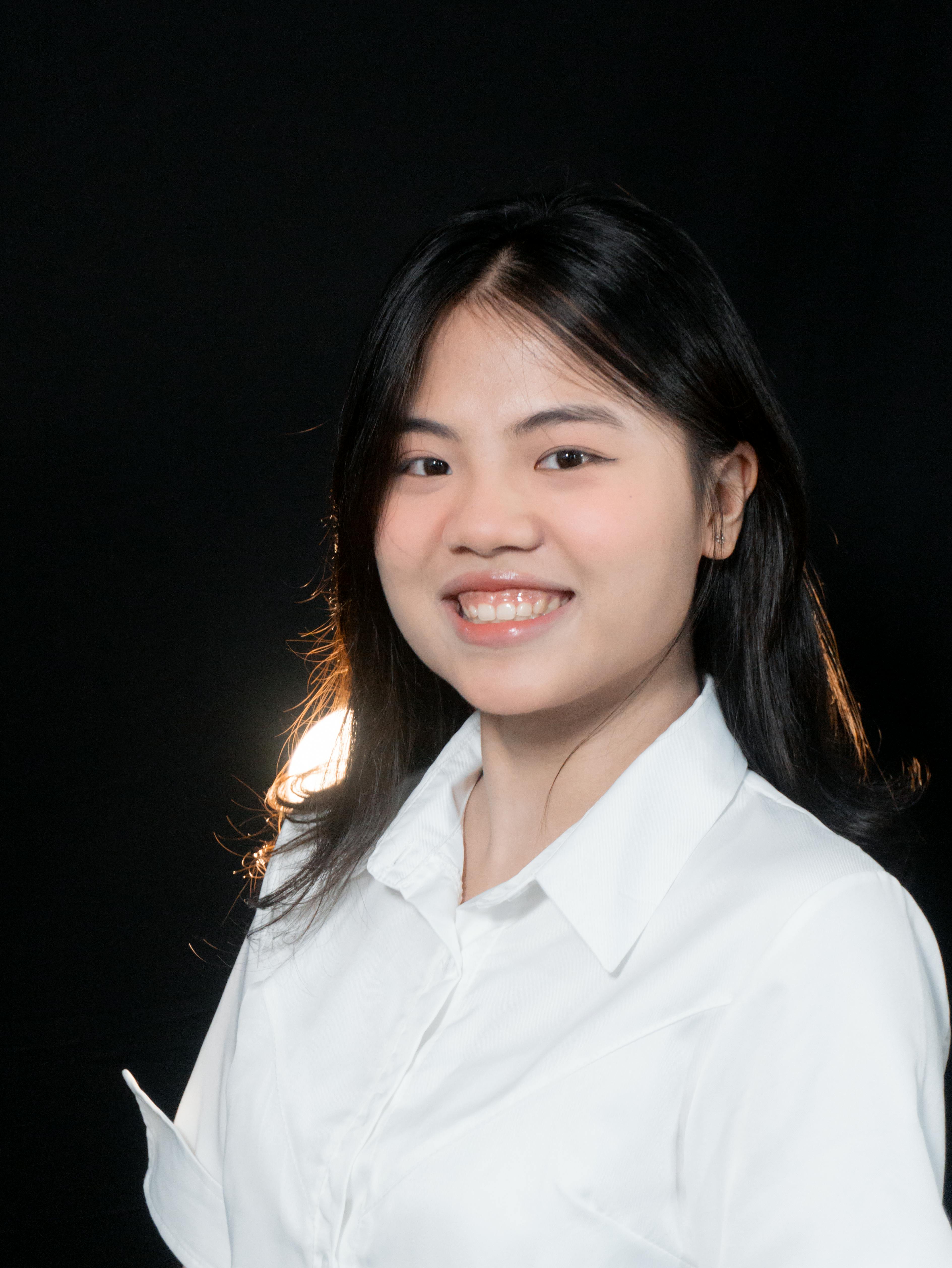 Smiling Young Woman in White Shirt on Black Background · Free Stock Photo