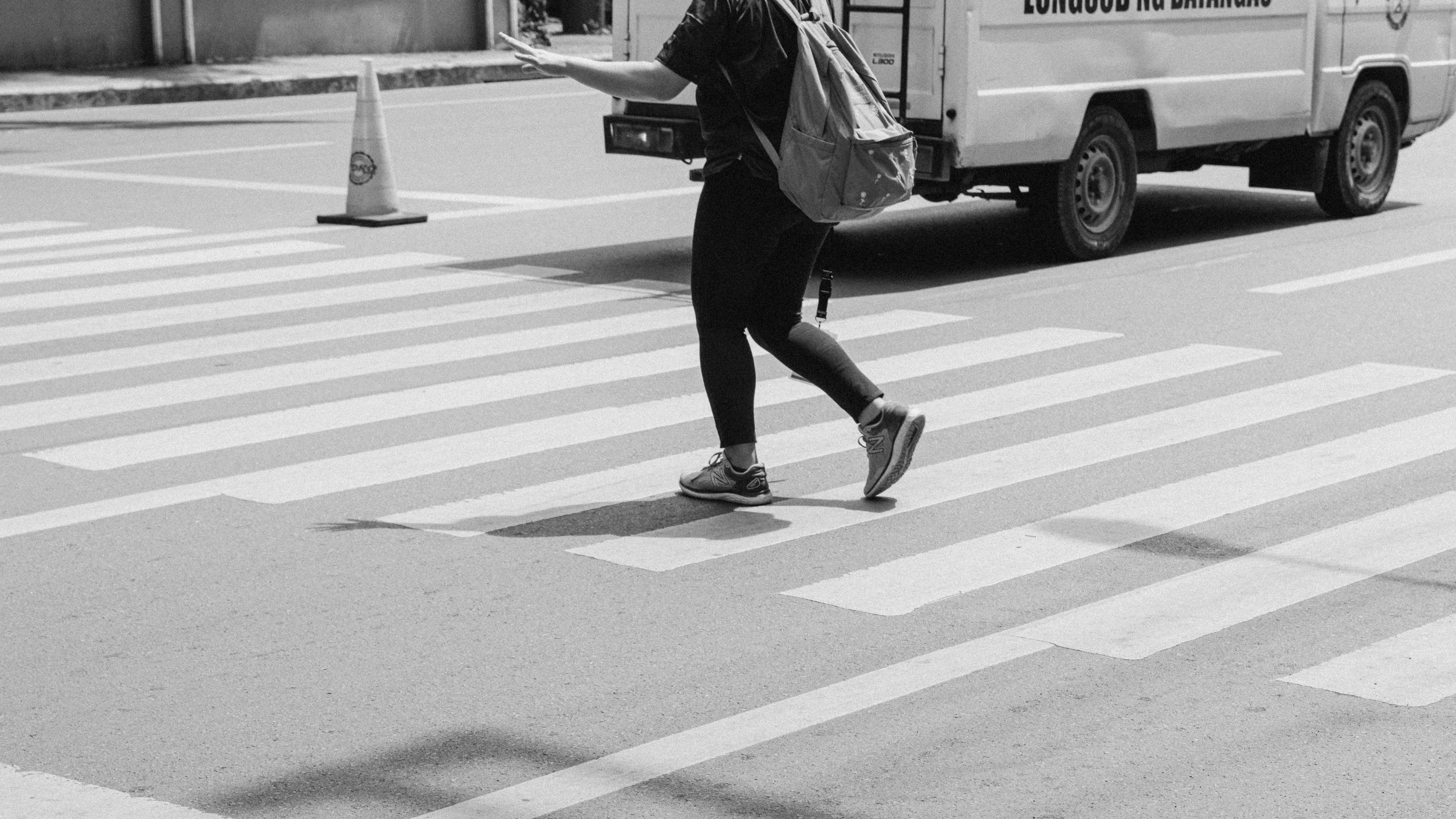 Person Crossing Street at Crosswalk in Urban Setting · Free Stock Photo