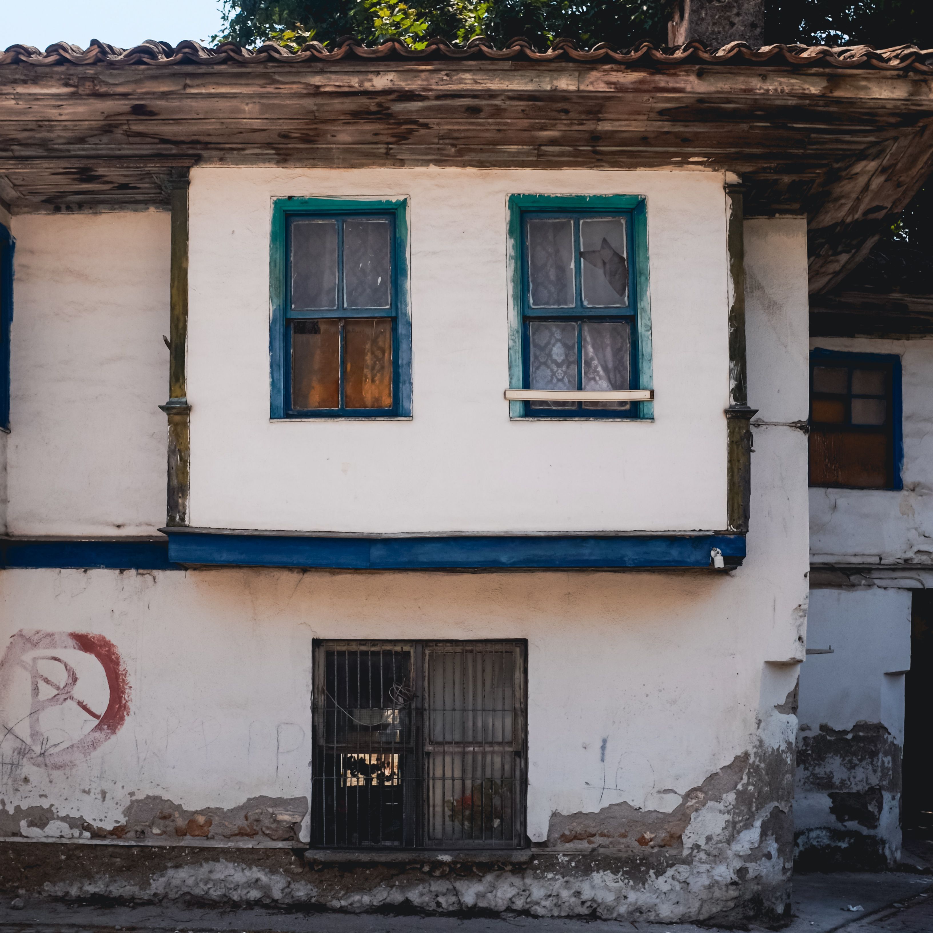 Weathered Exterior of Vintage Building with Blue Trim · Free Stock Photo