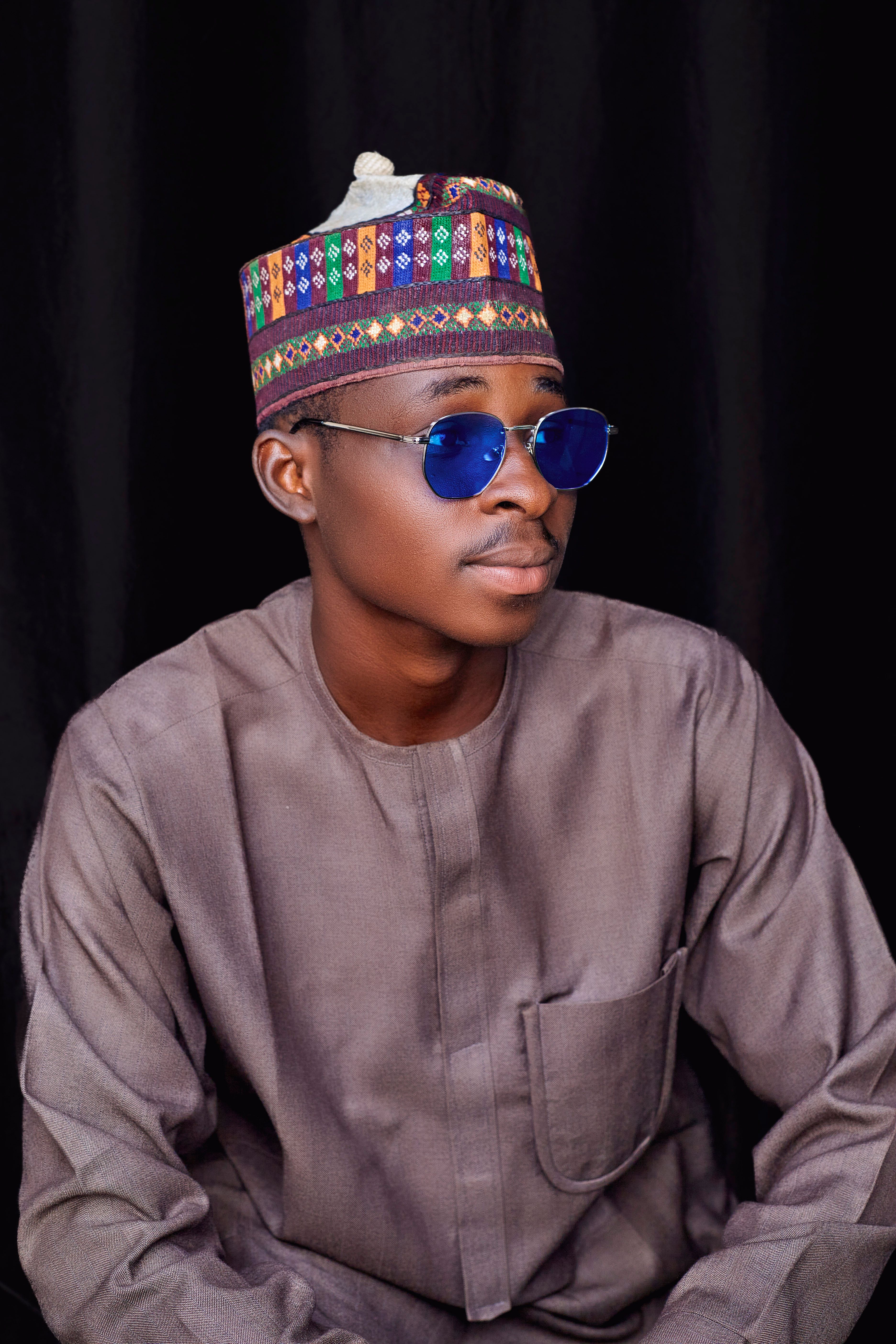 Young Man in Traditional Nigerian Attire with Sunglasses · Free Stock Photo