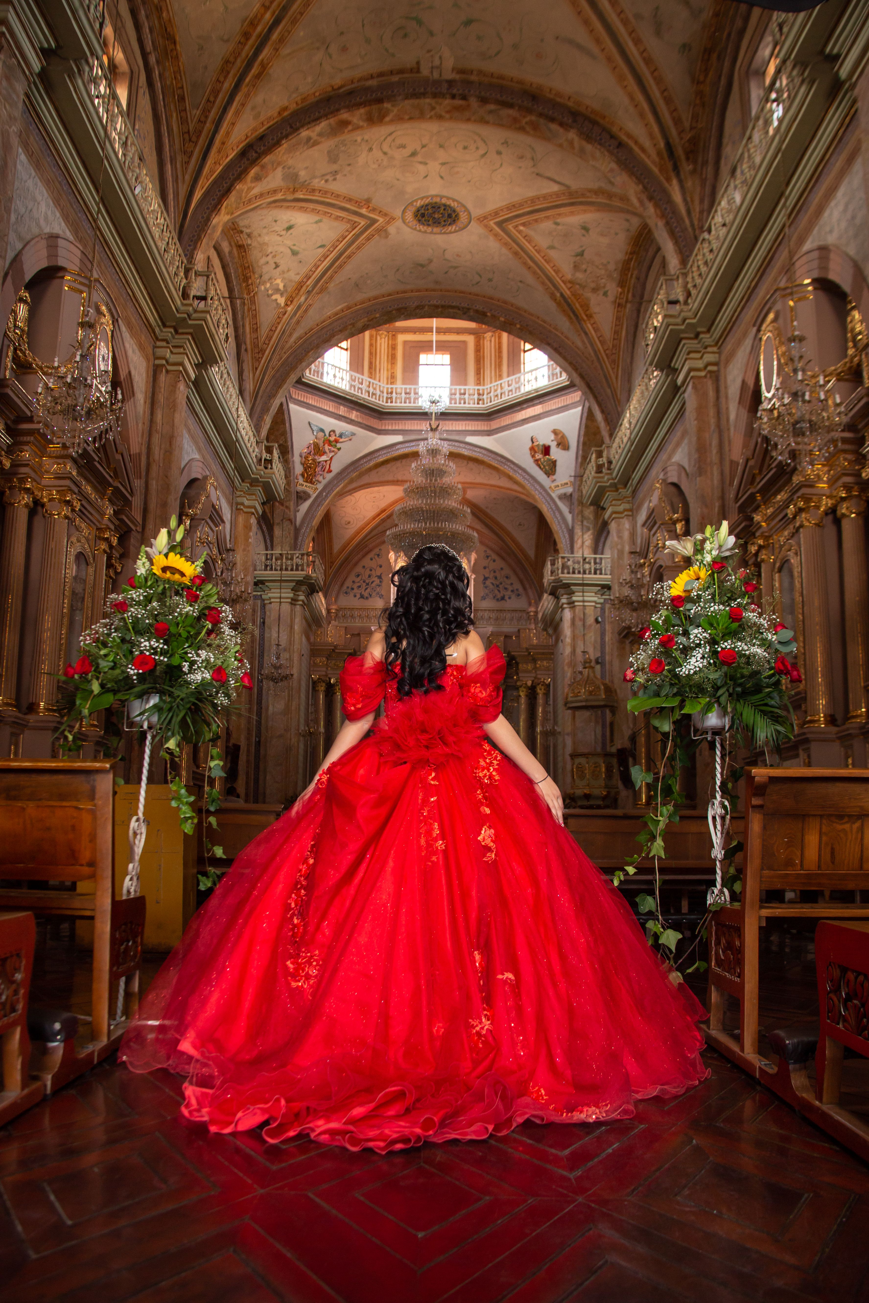 Quinceañera in Stunning Red Gown Inside Historic Church · Free Stock Photo