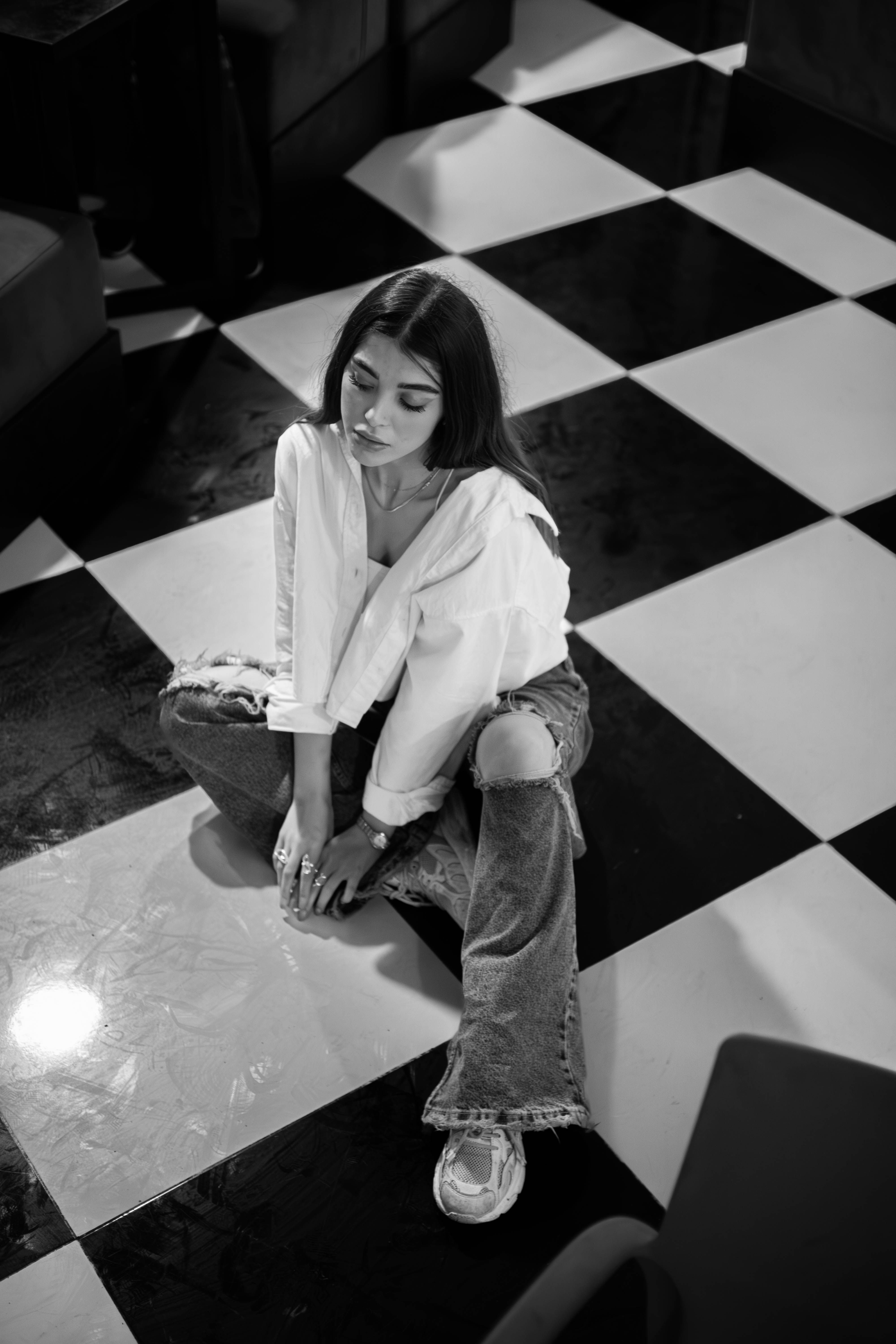 Black and White Portrait on Checkered Floor · Free Stock Photo