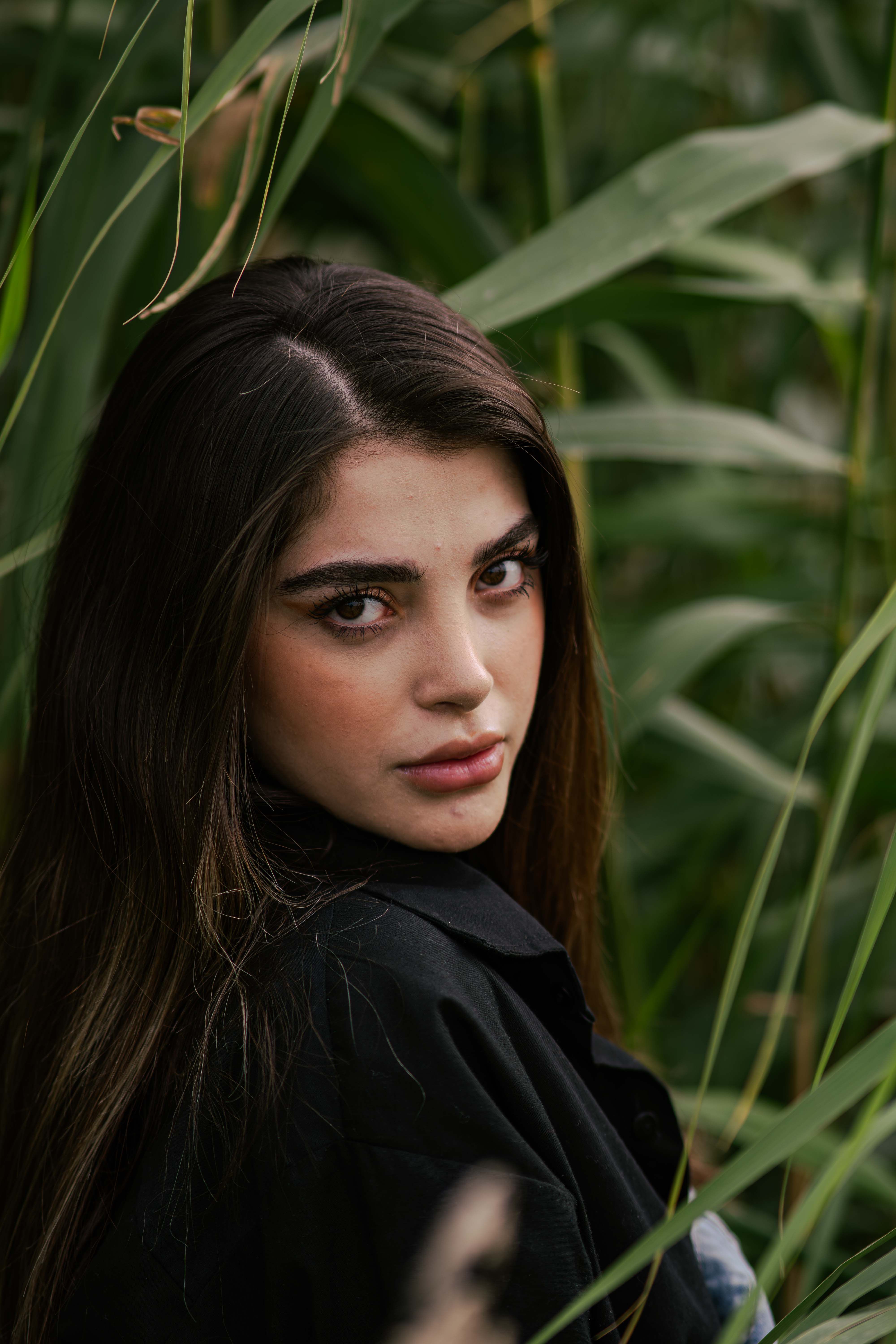 Portrait of a Woman in Lush Greenery · Free Stock Photo