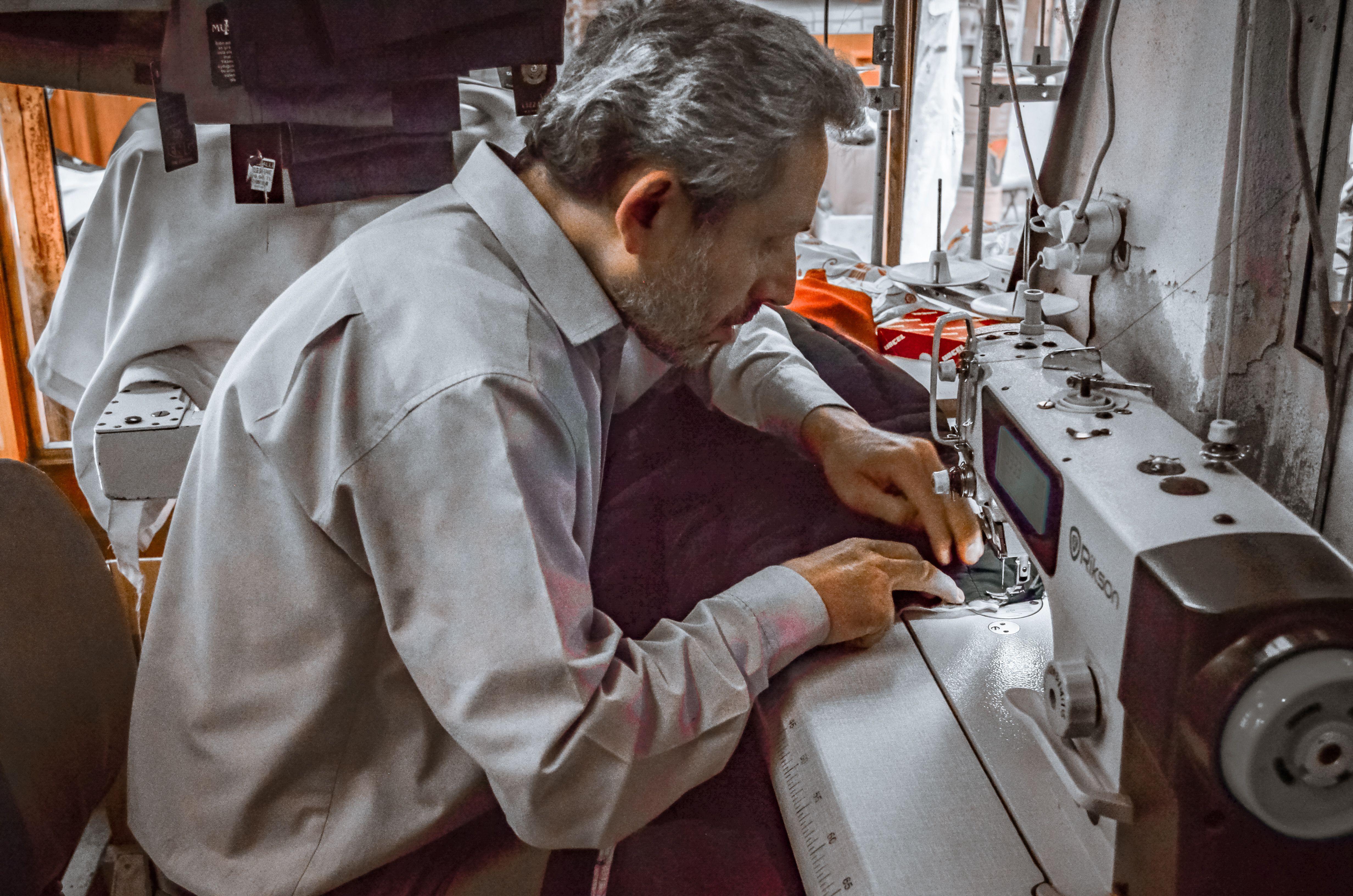 Tailor Sewing Clothes with Industrial Machine · Free Stock Photo