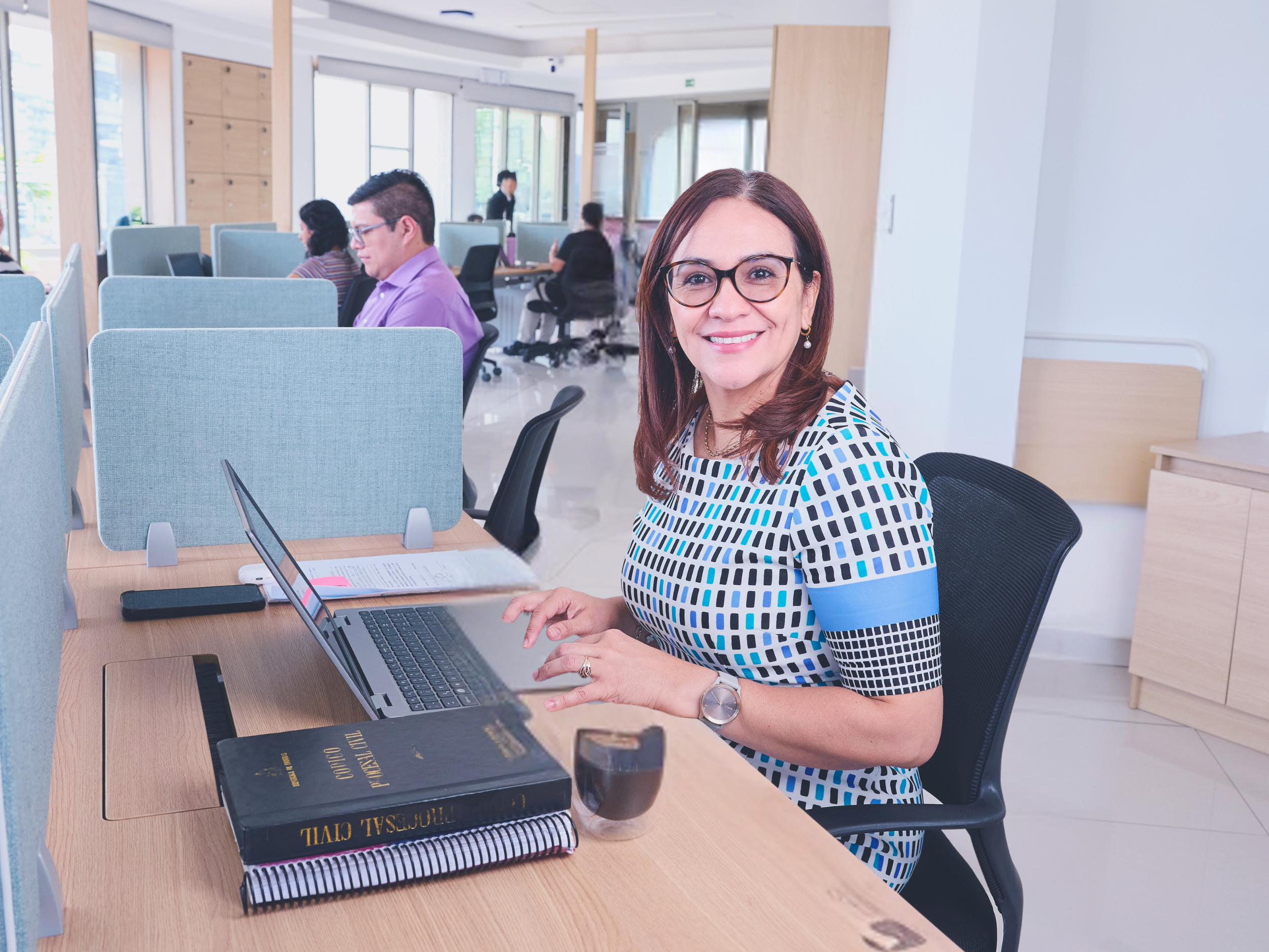 Professional Woman Smiling at Work Desk · Free Stock Photo