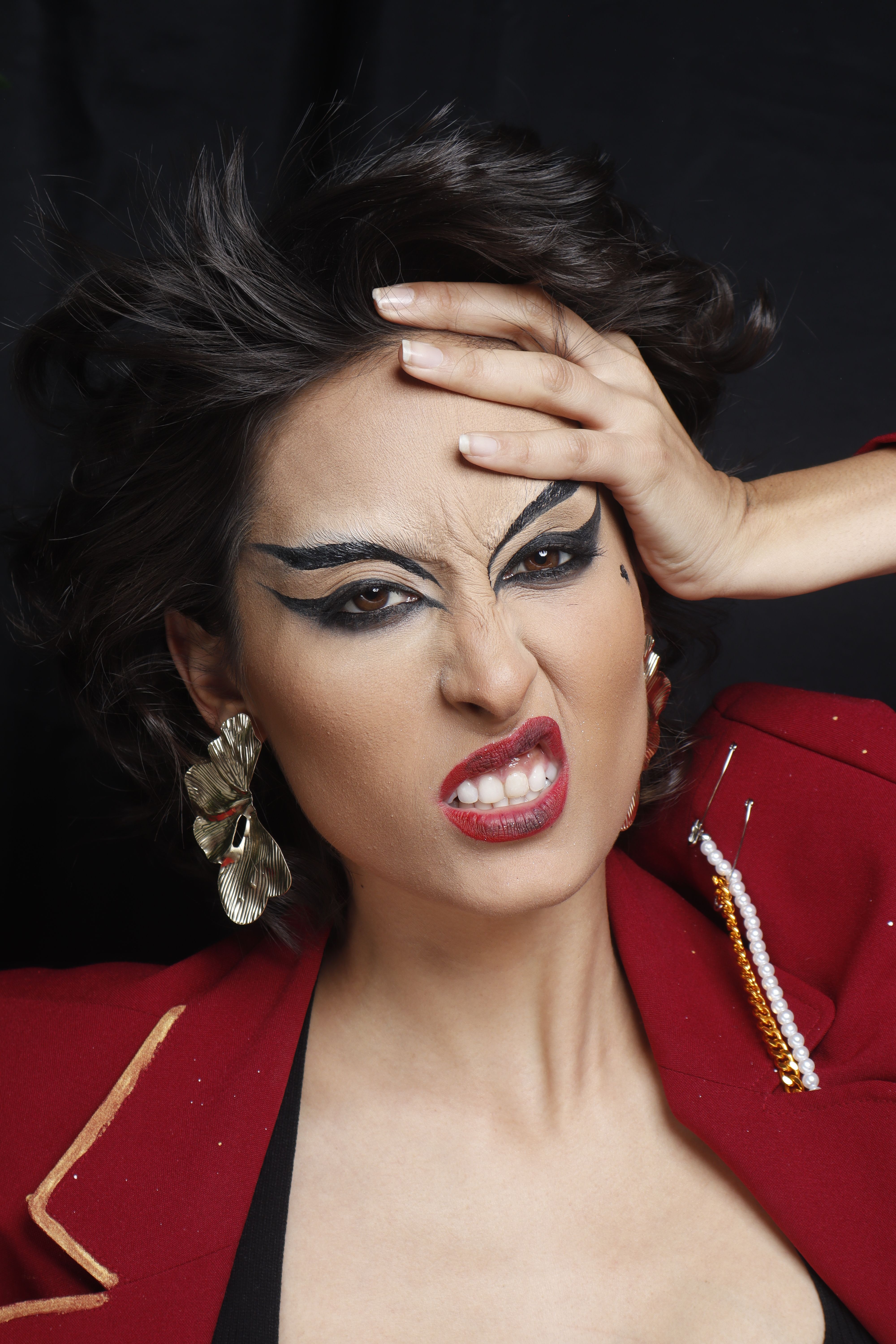 Expressive Woman with Bold Makeup and Fashionable Earrings · Free Stock ...