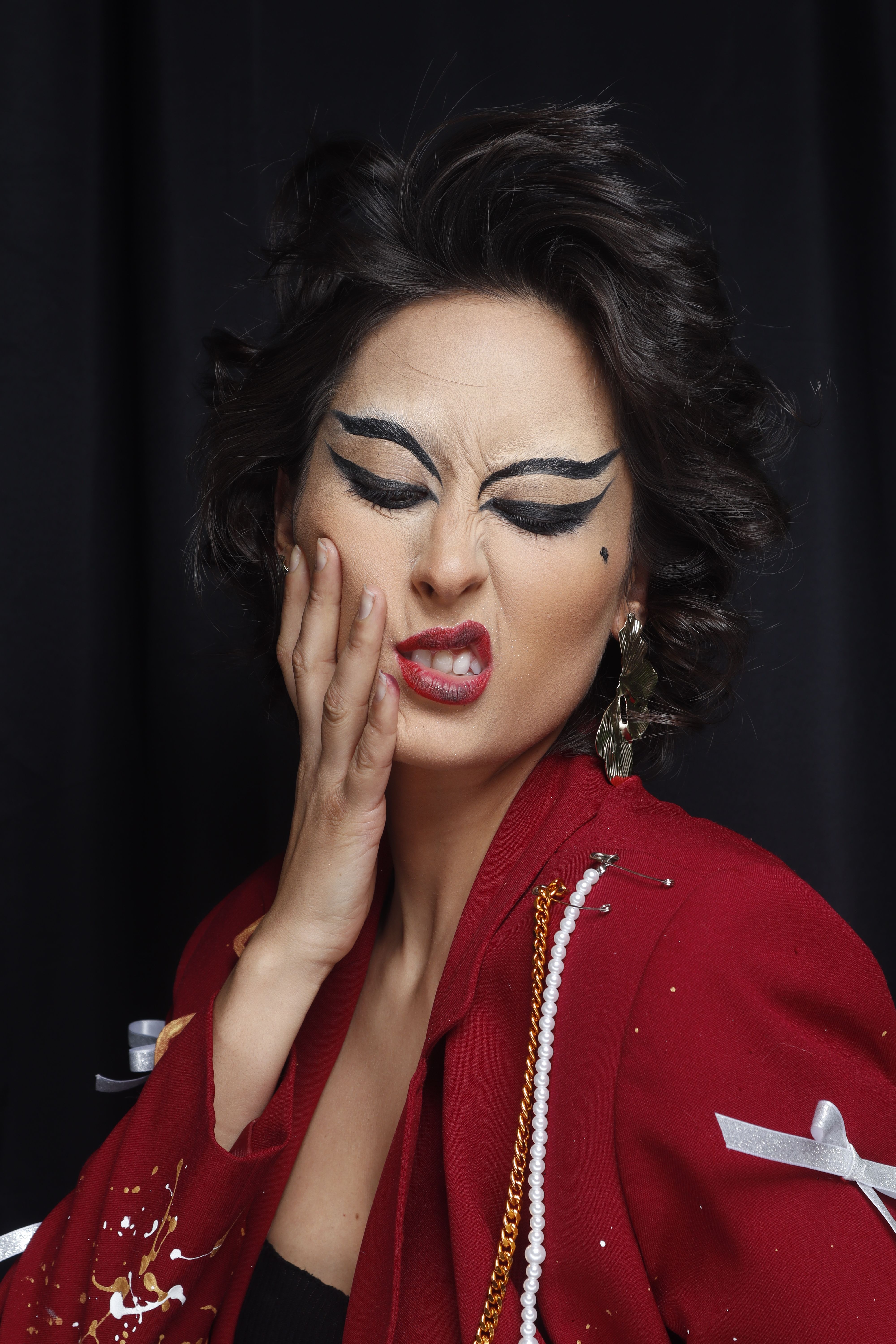 Expressive Woman with Bold Makeup and Fashionable Earrings · Free Stock ...