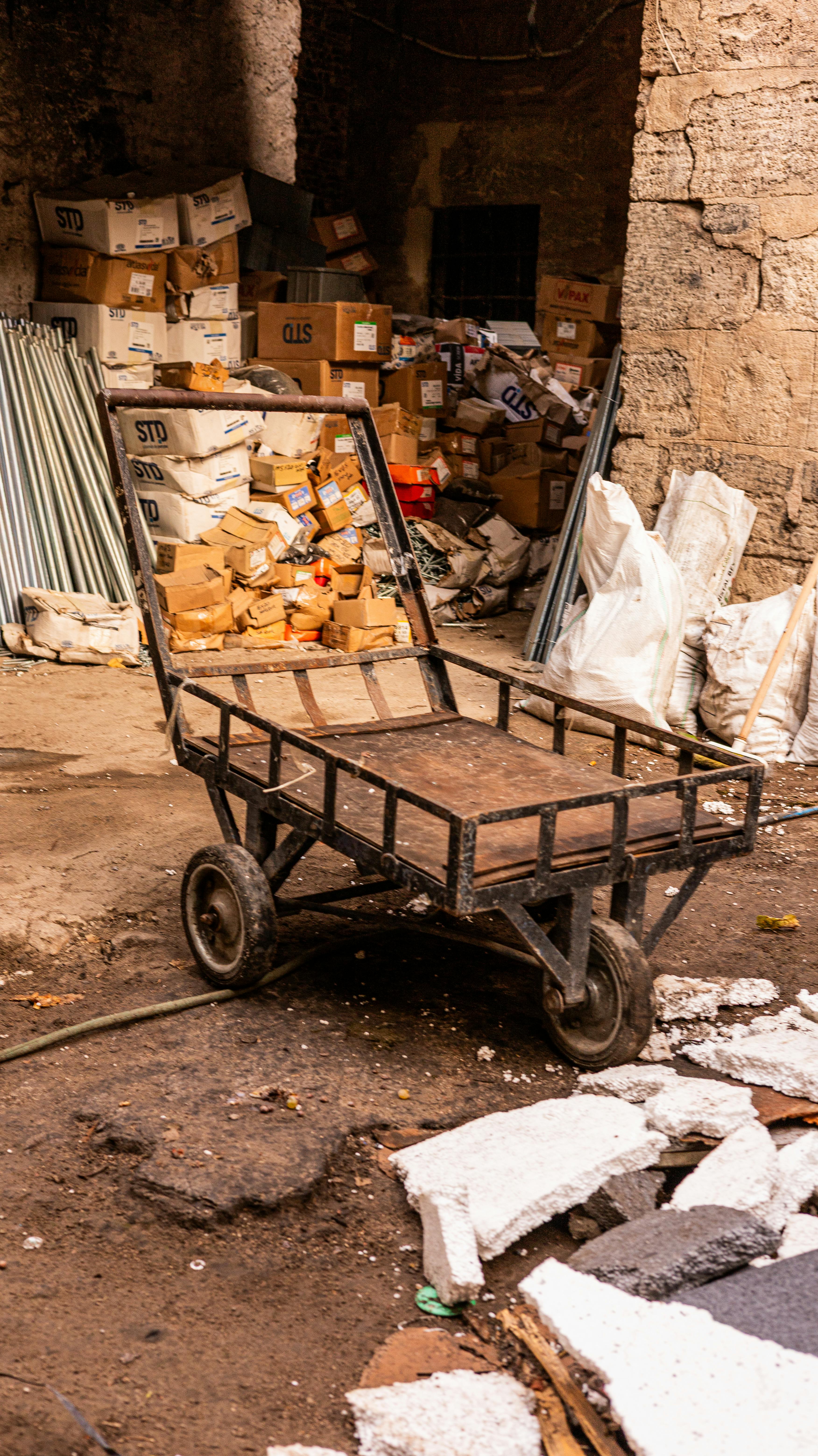 Old Handcart in a Rustic Warehouse Setting · Free Stock Photo