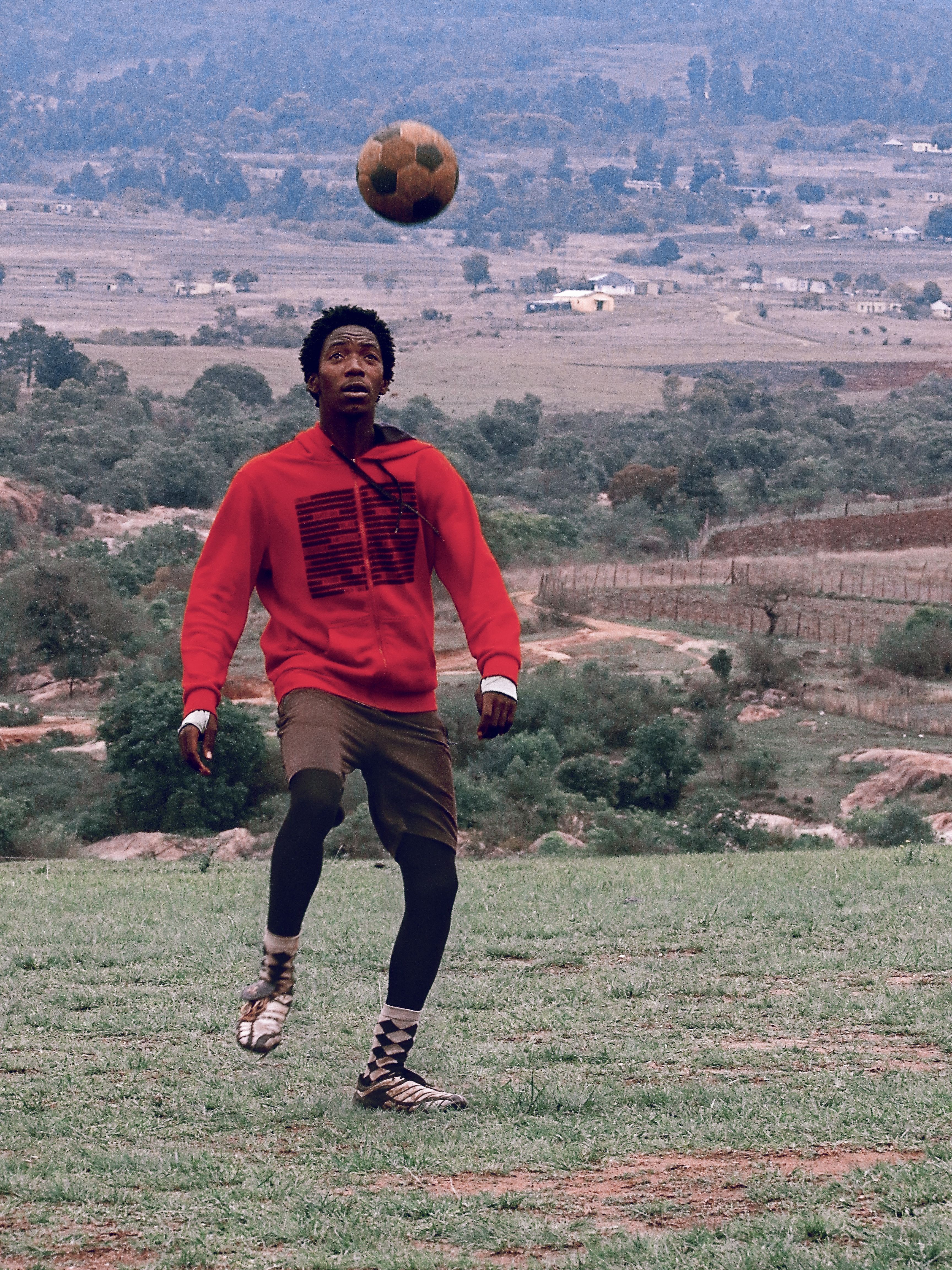 Young Man Playing Soccer in Eswatini Countryside · Free Stock Photo