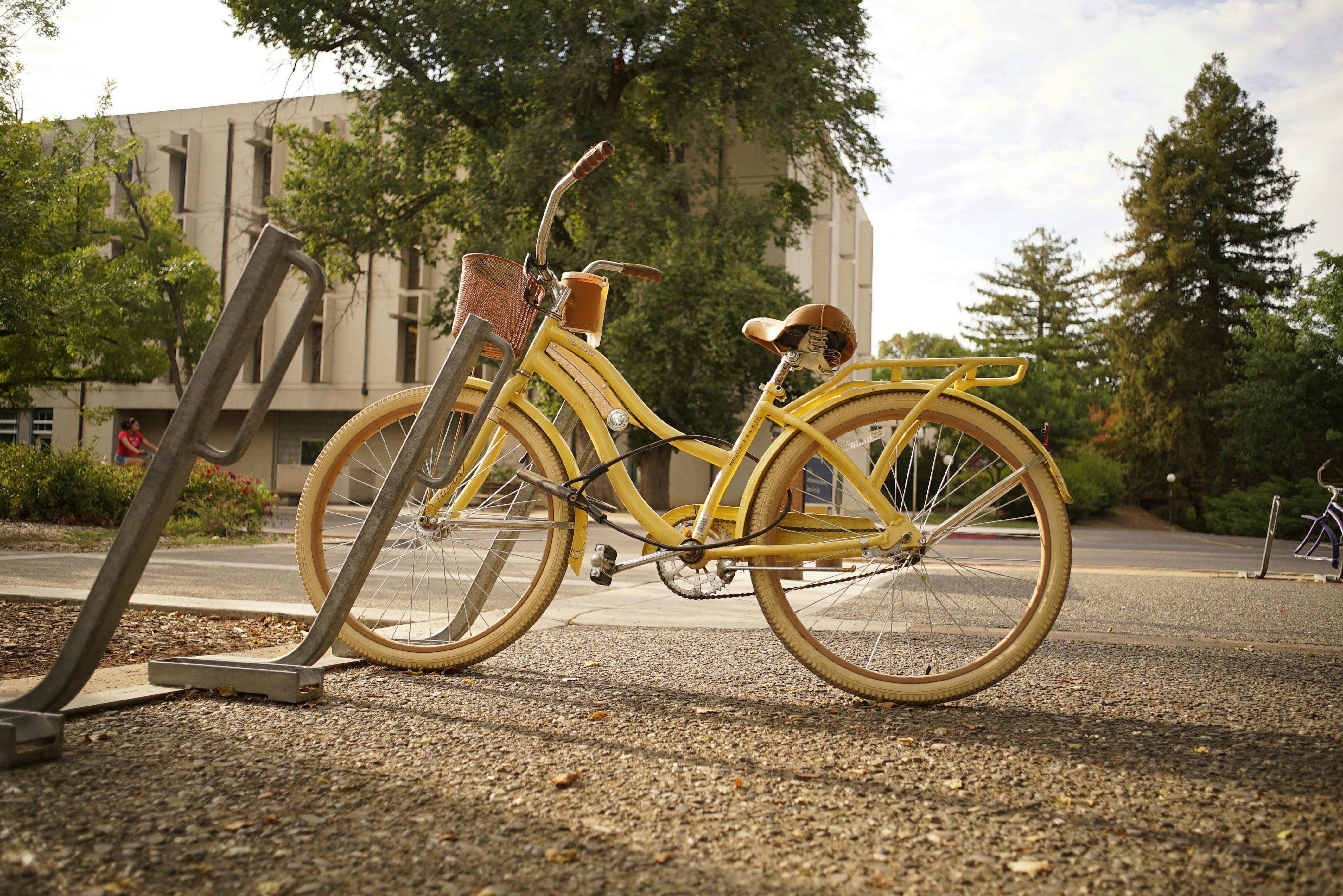 Vintage Yellow Bicycle Parked on Campus · Free Stock Photo