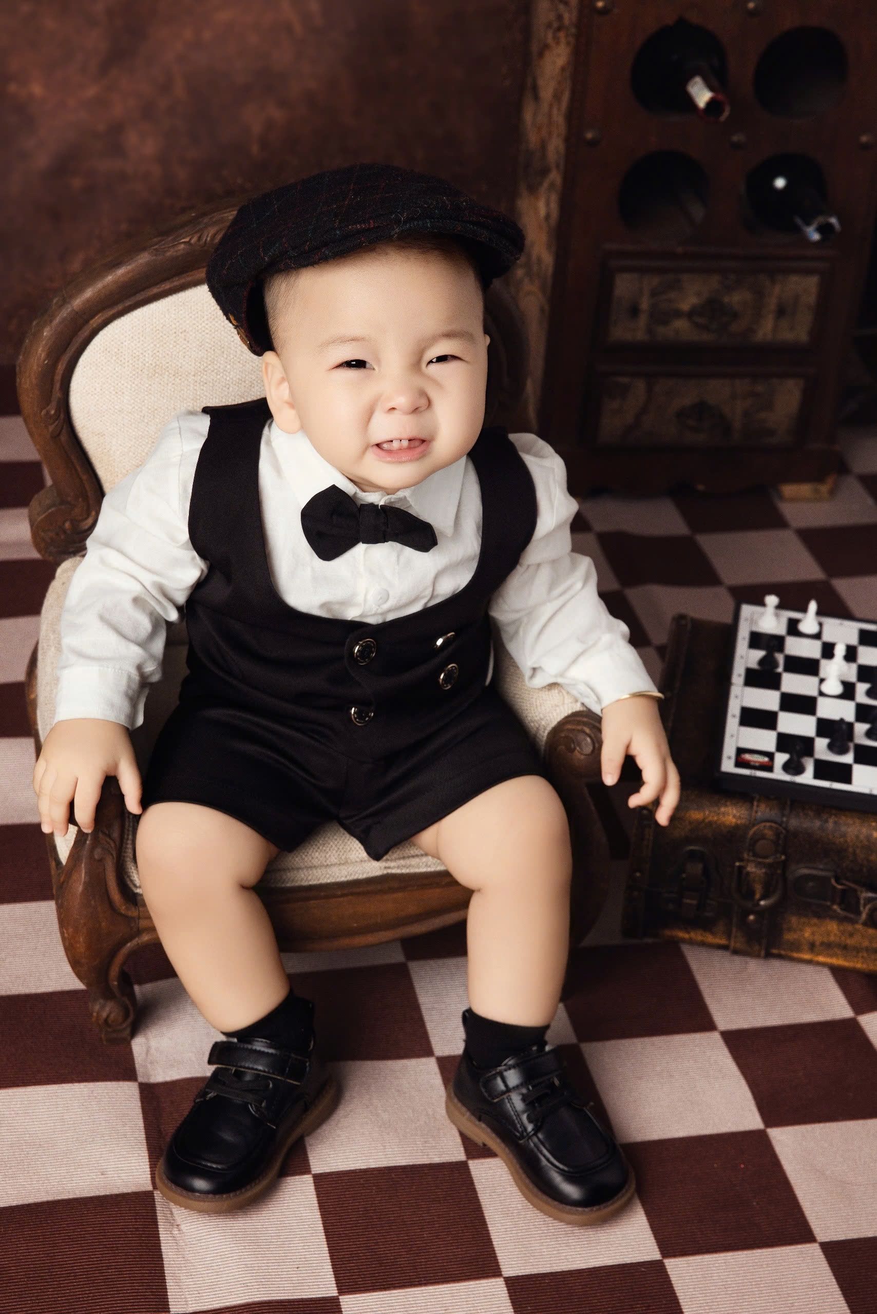 Crying Boy in Vintage Suit Sitting on Luggage · Free Stock Photo