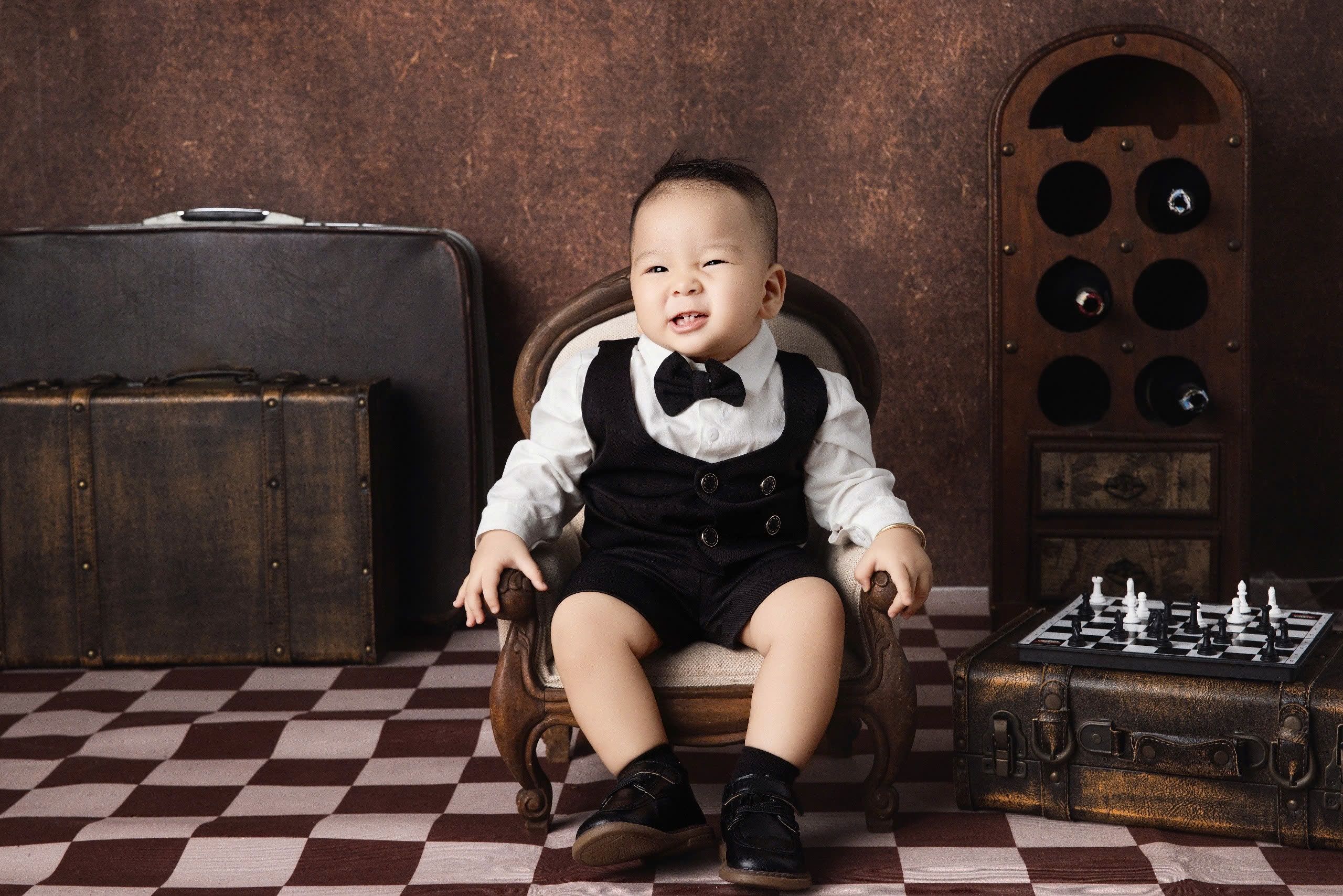 Crying Boy in Vintage Suit Sitting on Luggage · Free Stock Photo