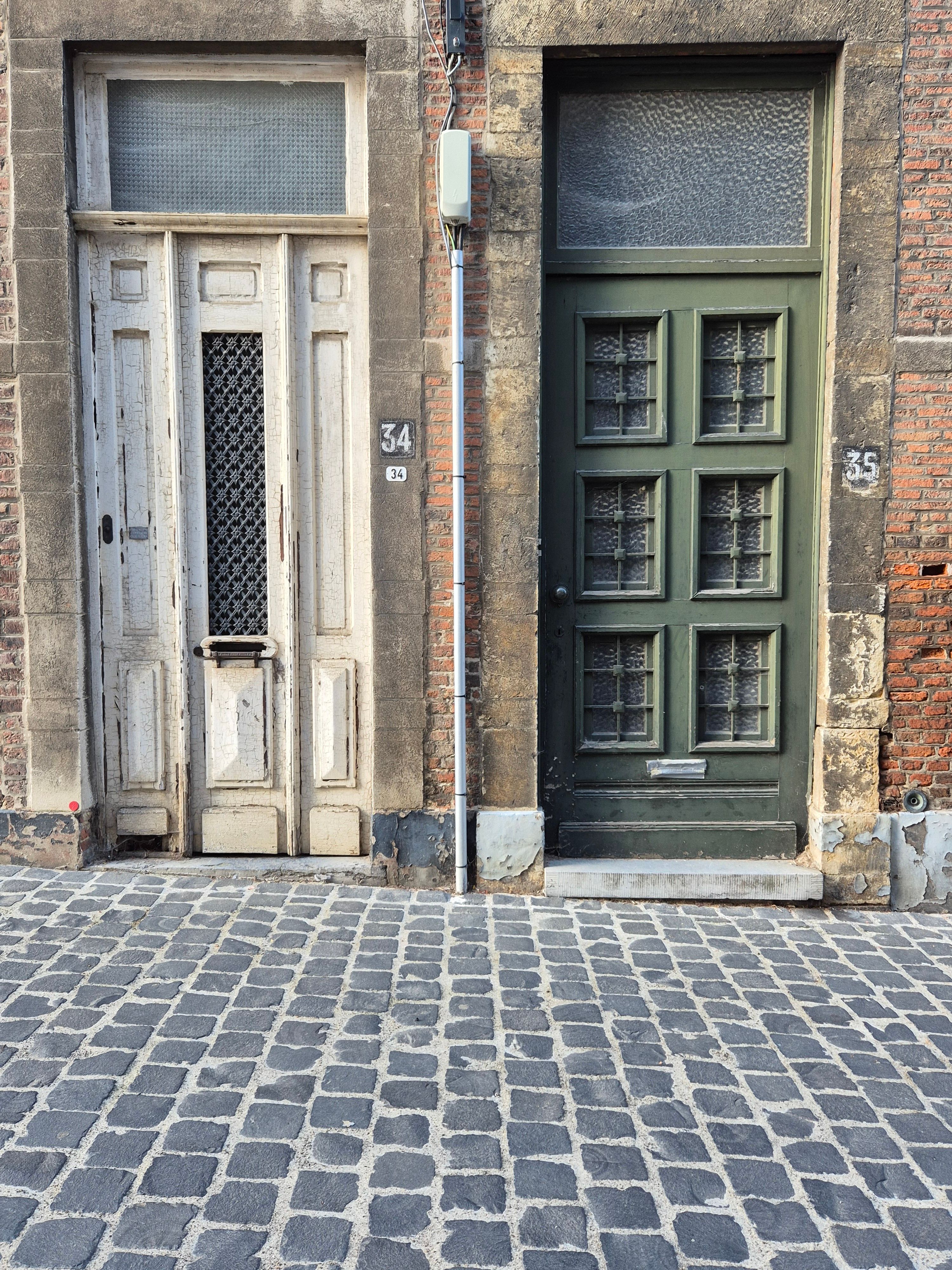 Vintage European Doorways on Cobblestone Street · Free Stock Photo