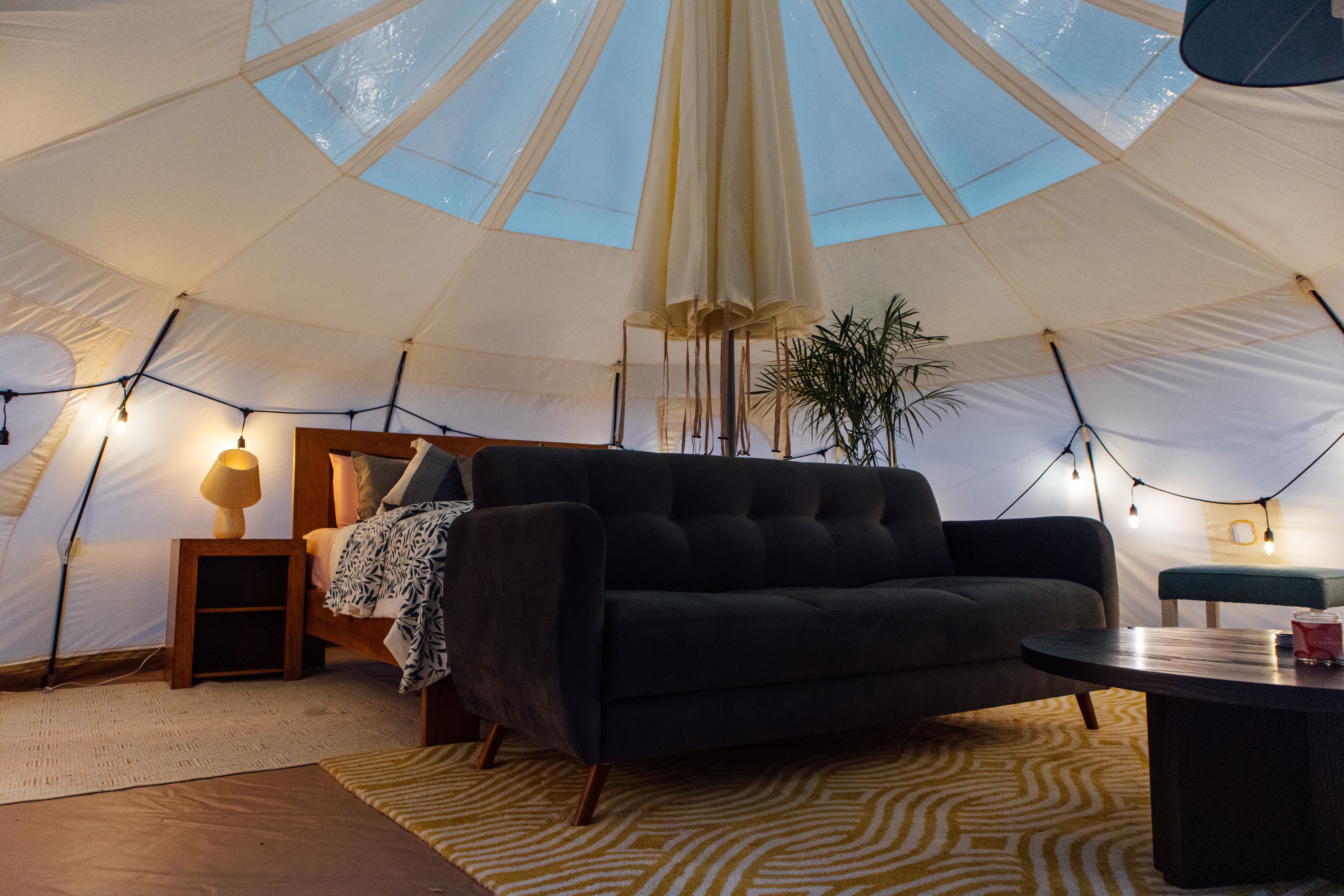 Luxurious Glamping Tent Interior with Sofa and Bed · Free Stock Photo