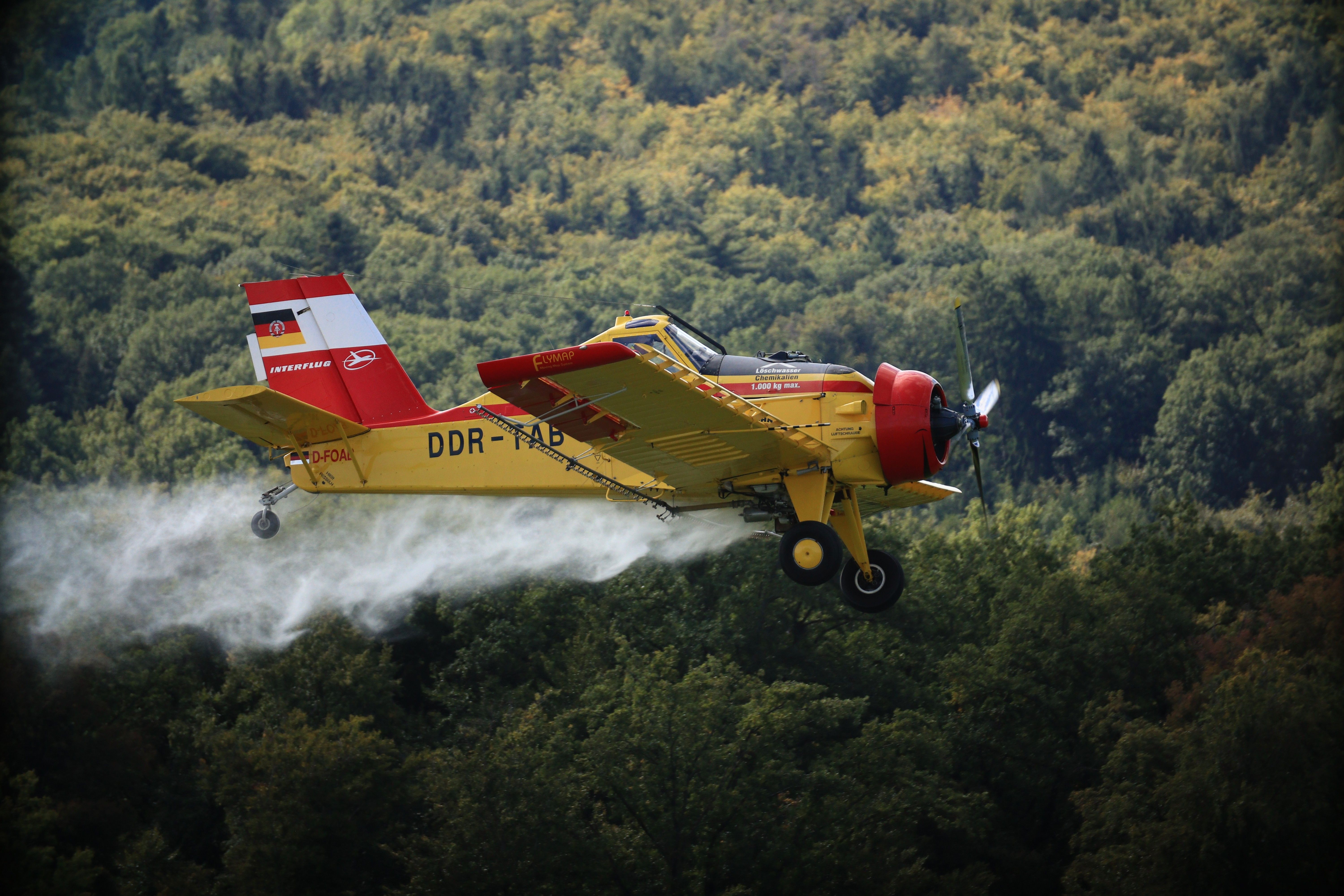 Aerial Shot of Crop Dusting Plane Over Forests · Free Stock Photo