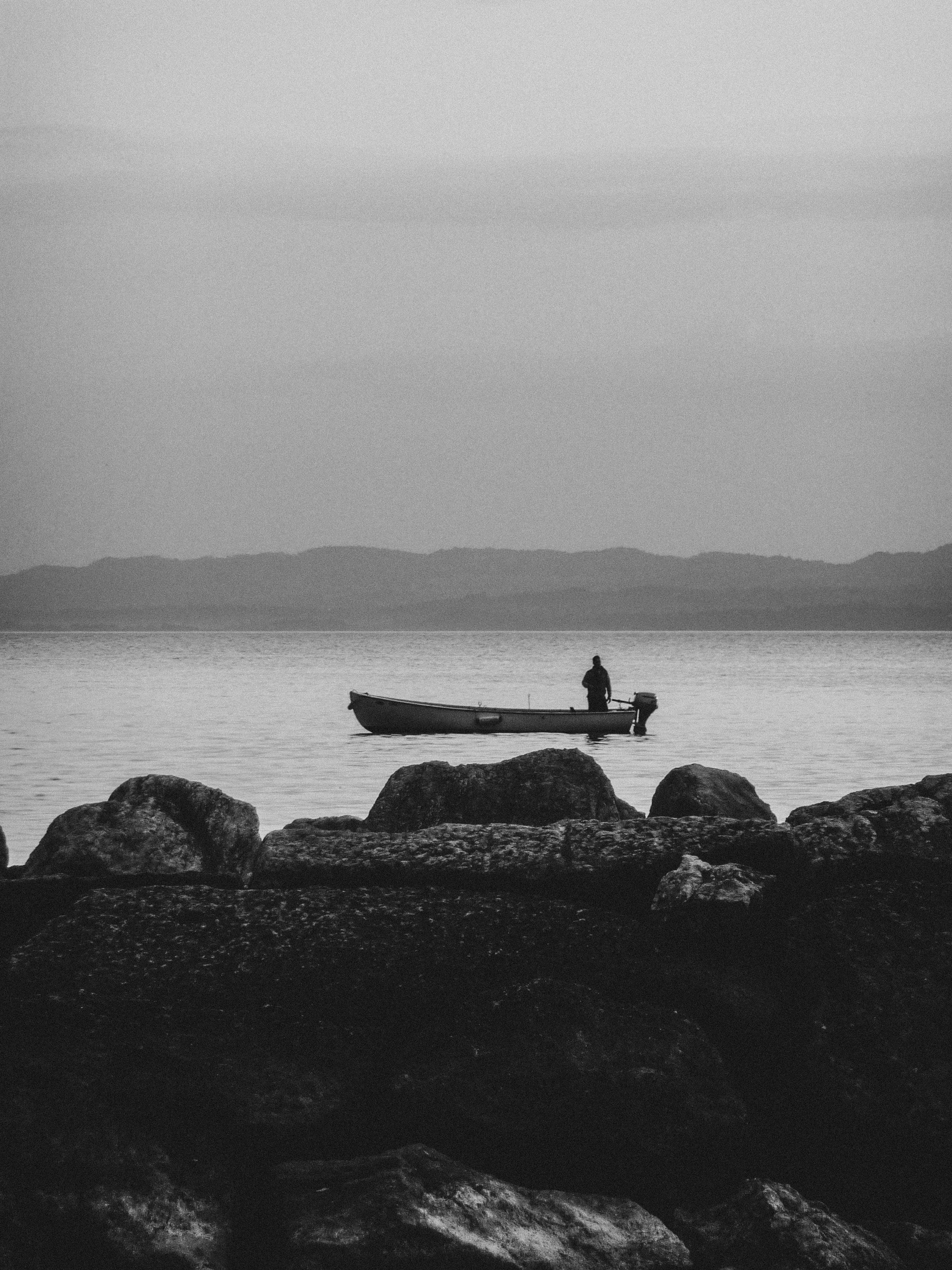 Lonely Fisherman on a Tranquil Lake · Free Stock Photo