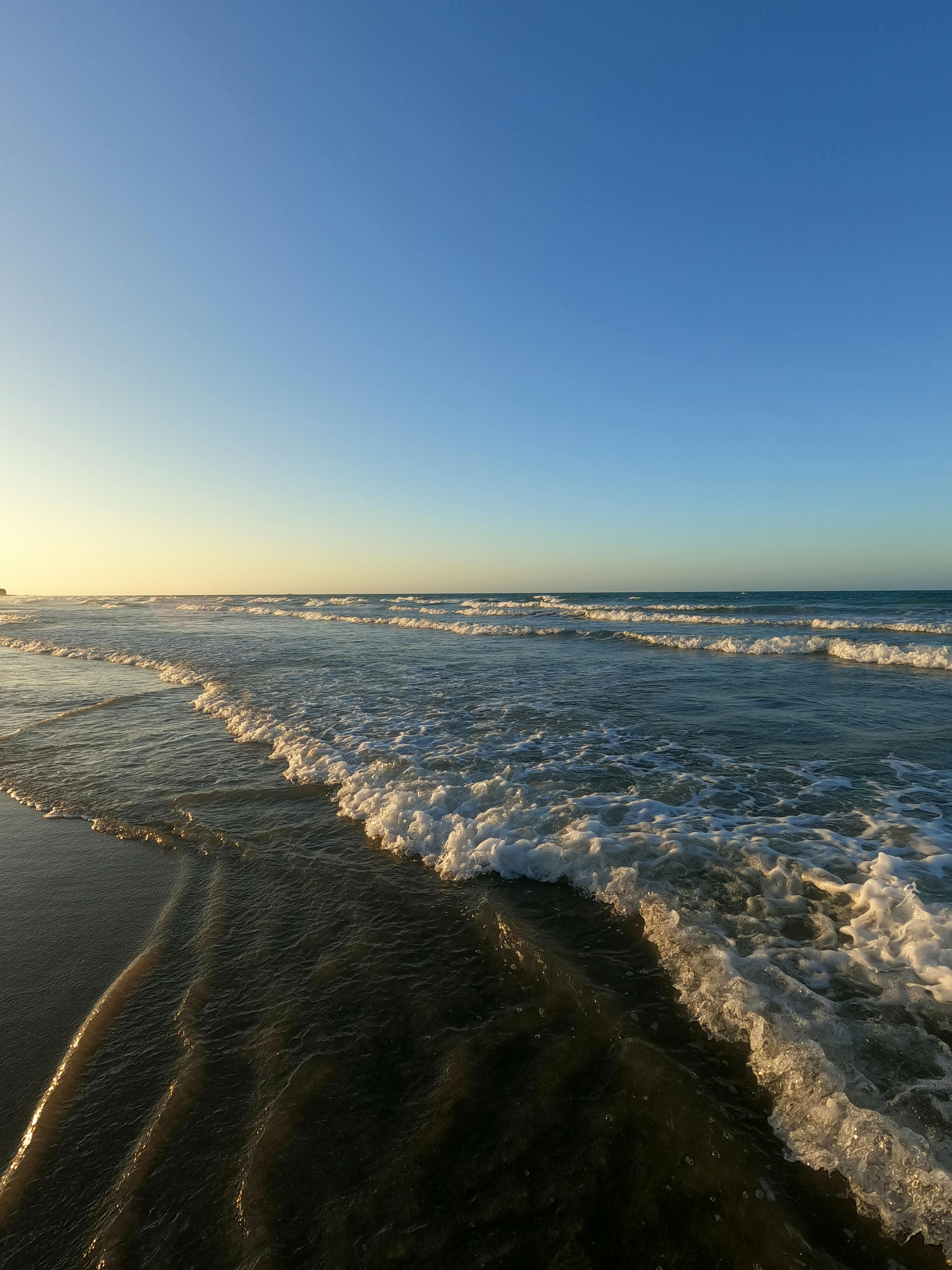 Sunrise Beach Waves on Tranquil Shoreline · Free Stock Photo