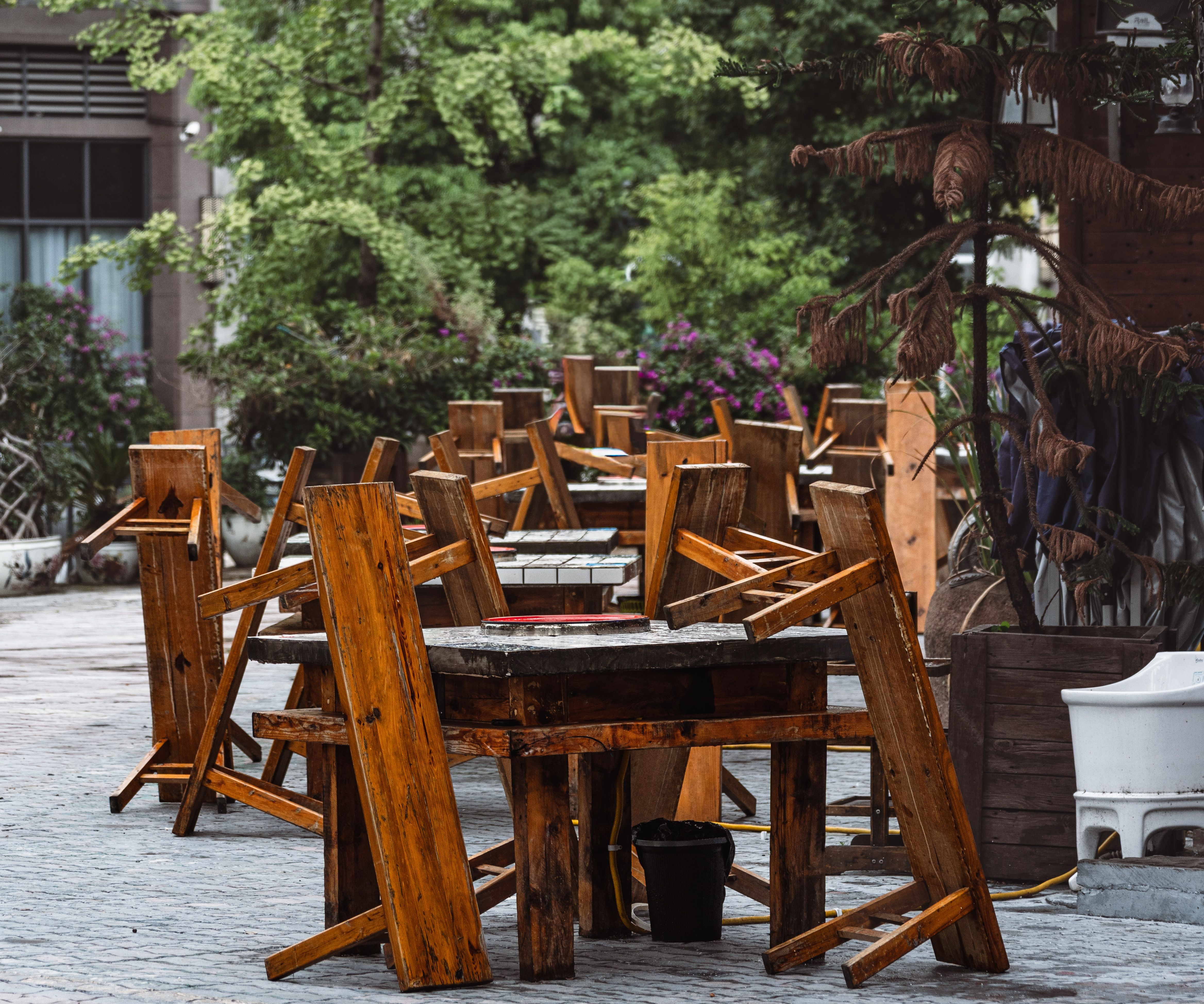 Outdoor Cafe with Upside Down Chairs on Tables · Free Stock Photo