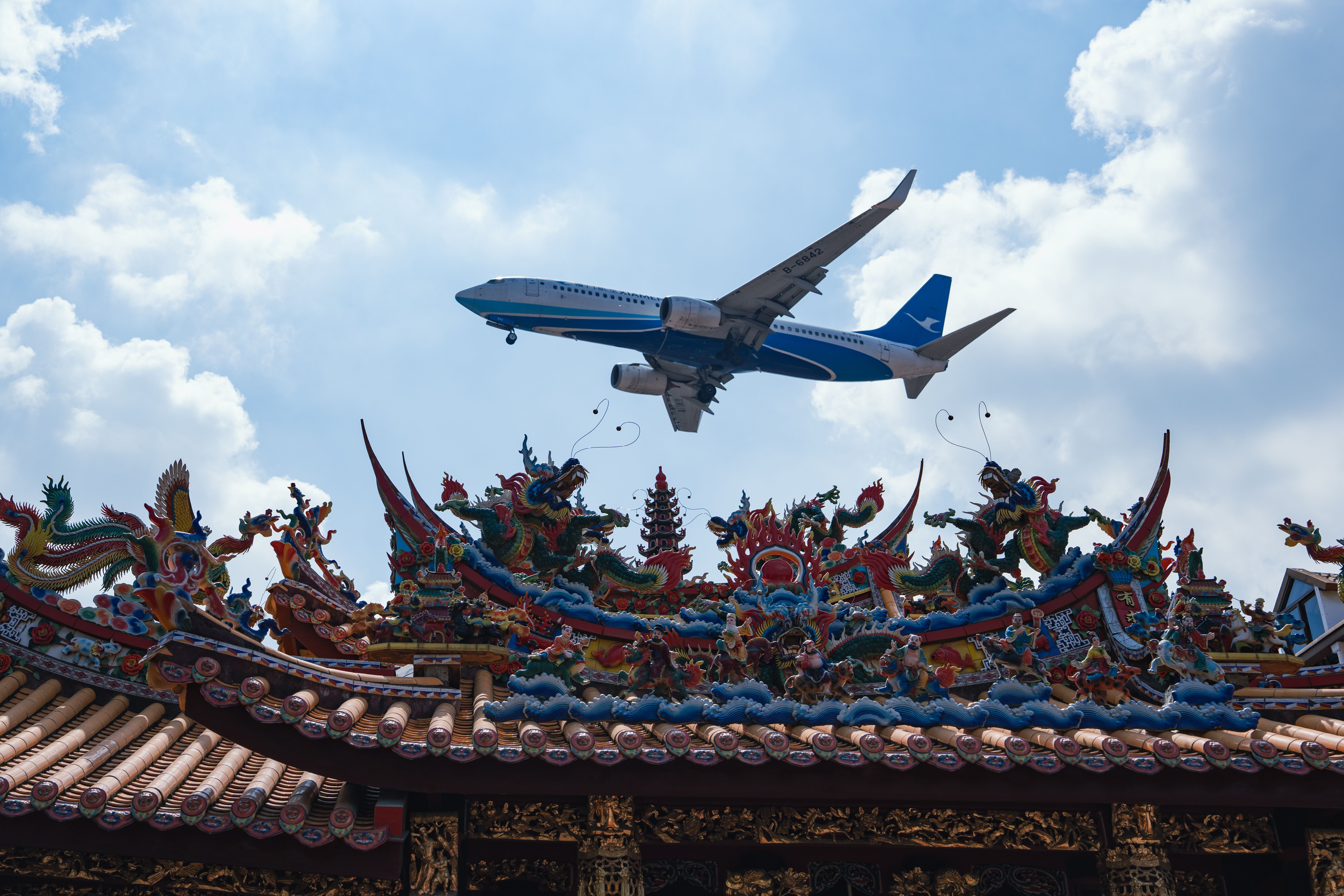 Passenger Airplane Flying over a Traditional Chinese Building · Free ...