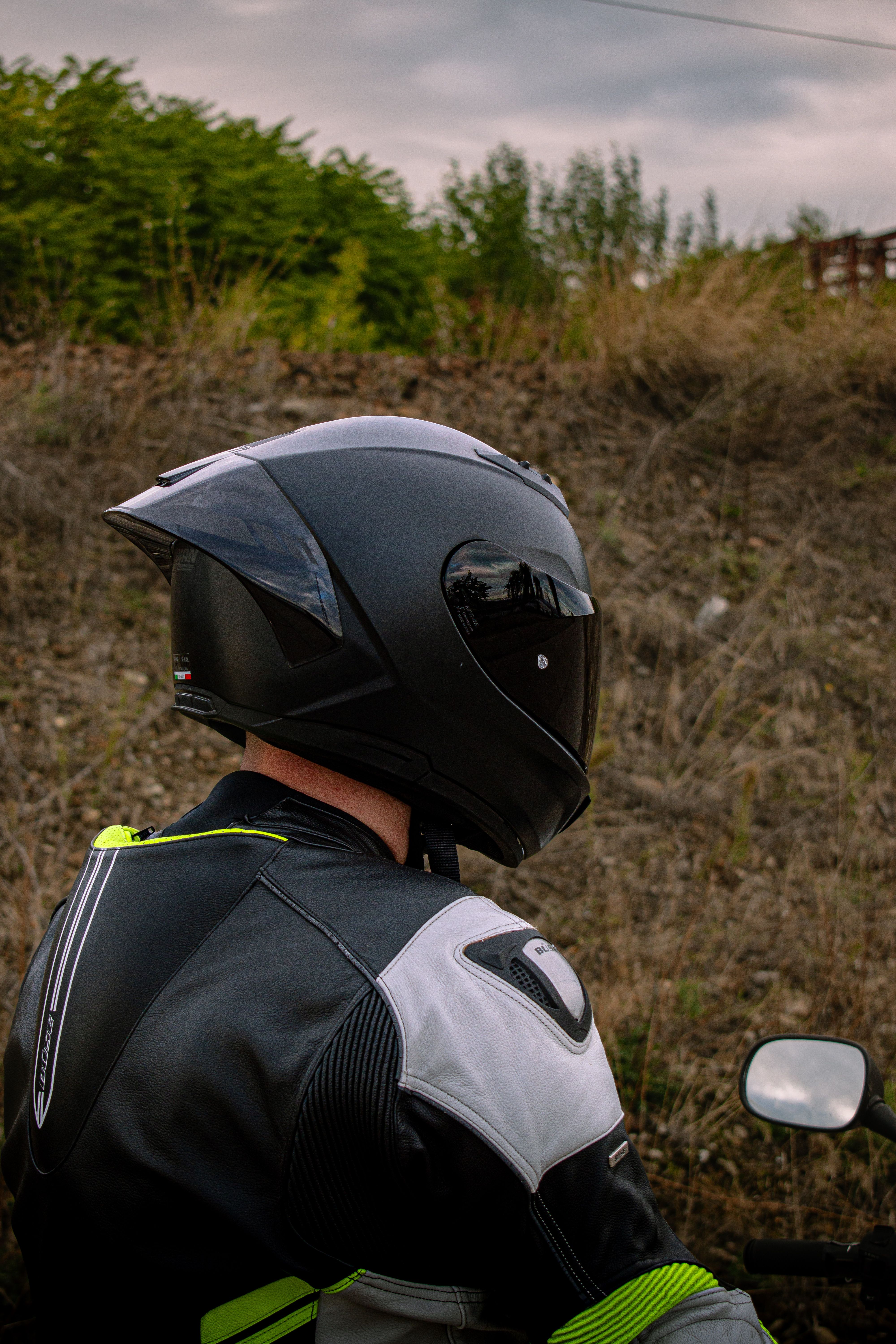 Motorcyclist with Black Helmet on Rural Road · Free Stock Photo